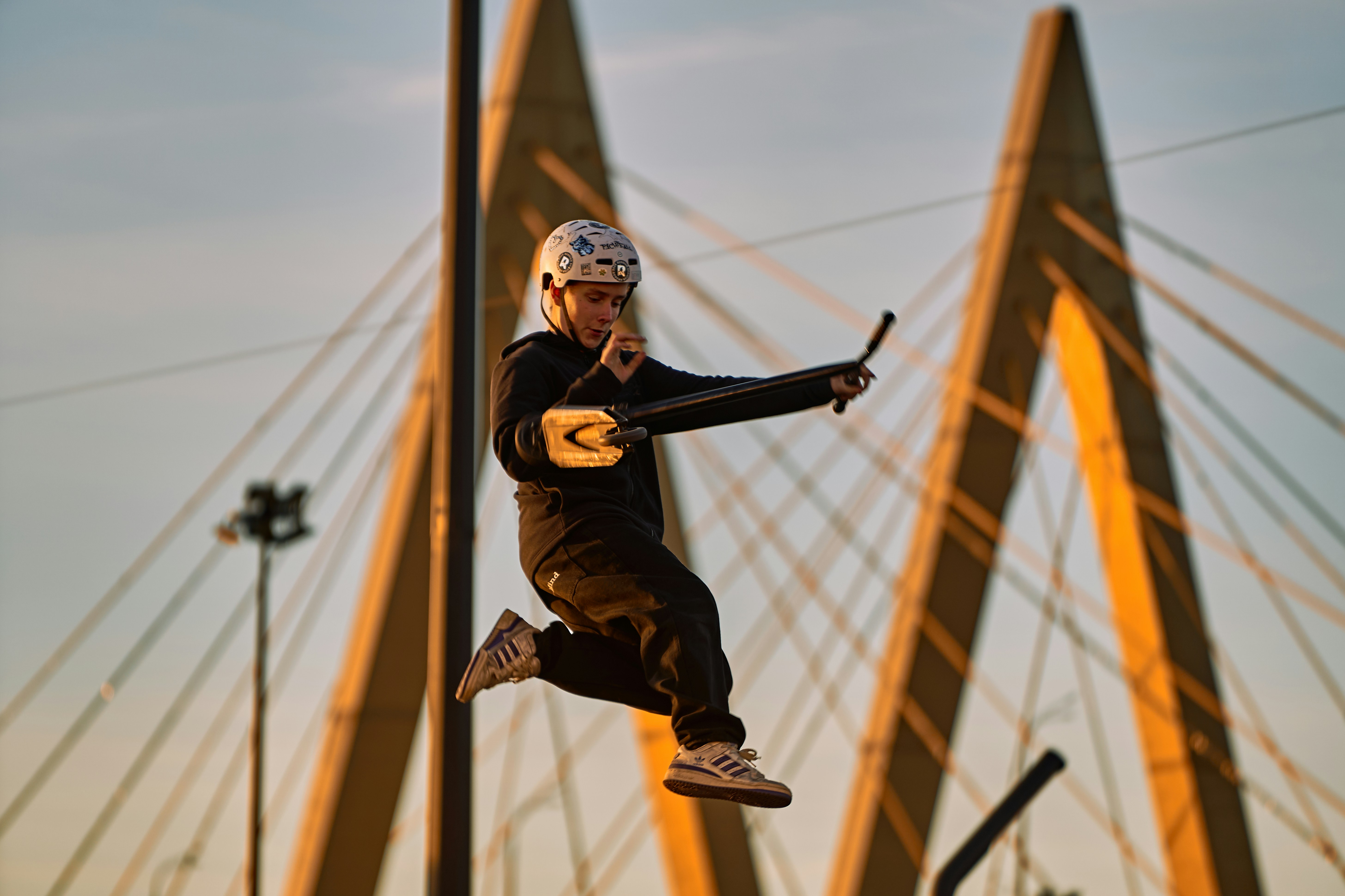 Faces used with permission | Person in mid-air jump with helmet and phone