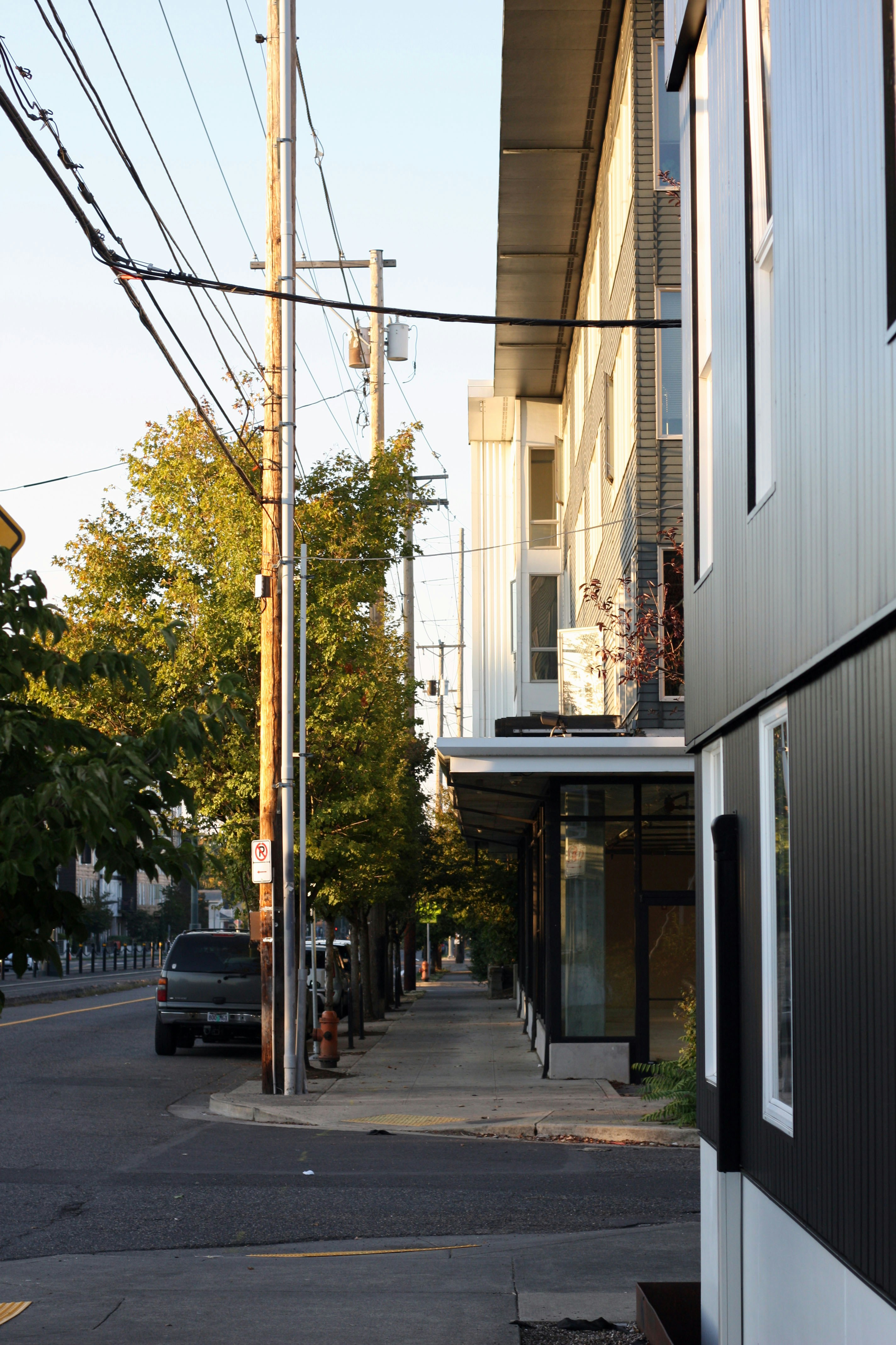 Sunlit Edge: A Street Corridor Framed by Modern Facades