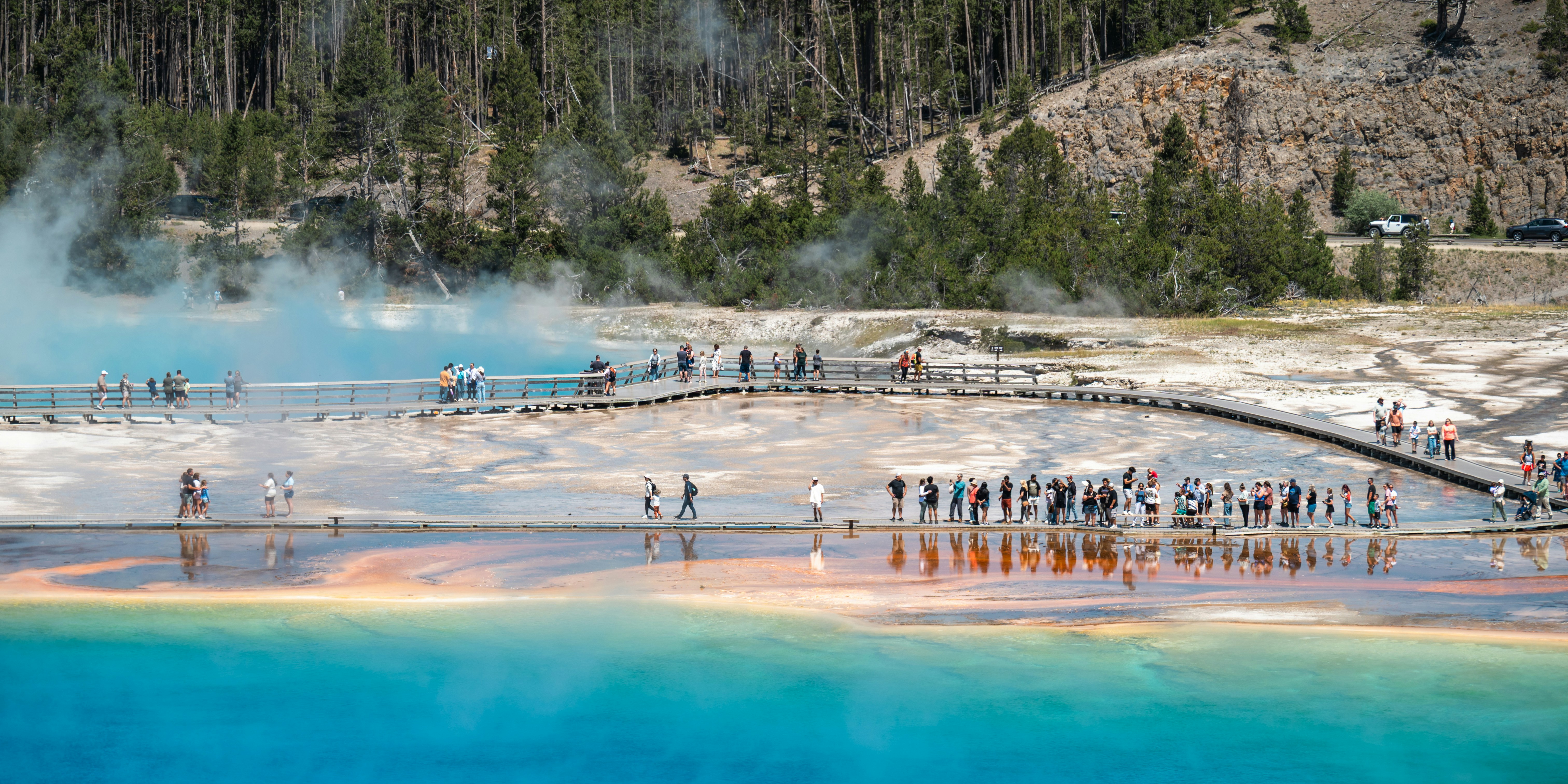 Turquoise Steamfields: People Traverse a Multicolored Geothermal Boardwalk
