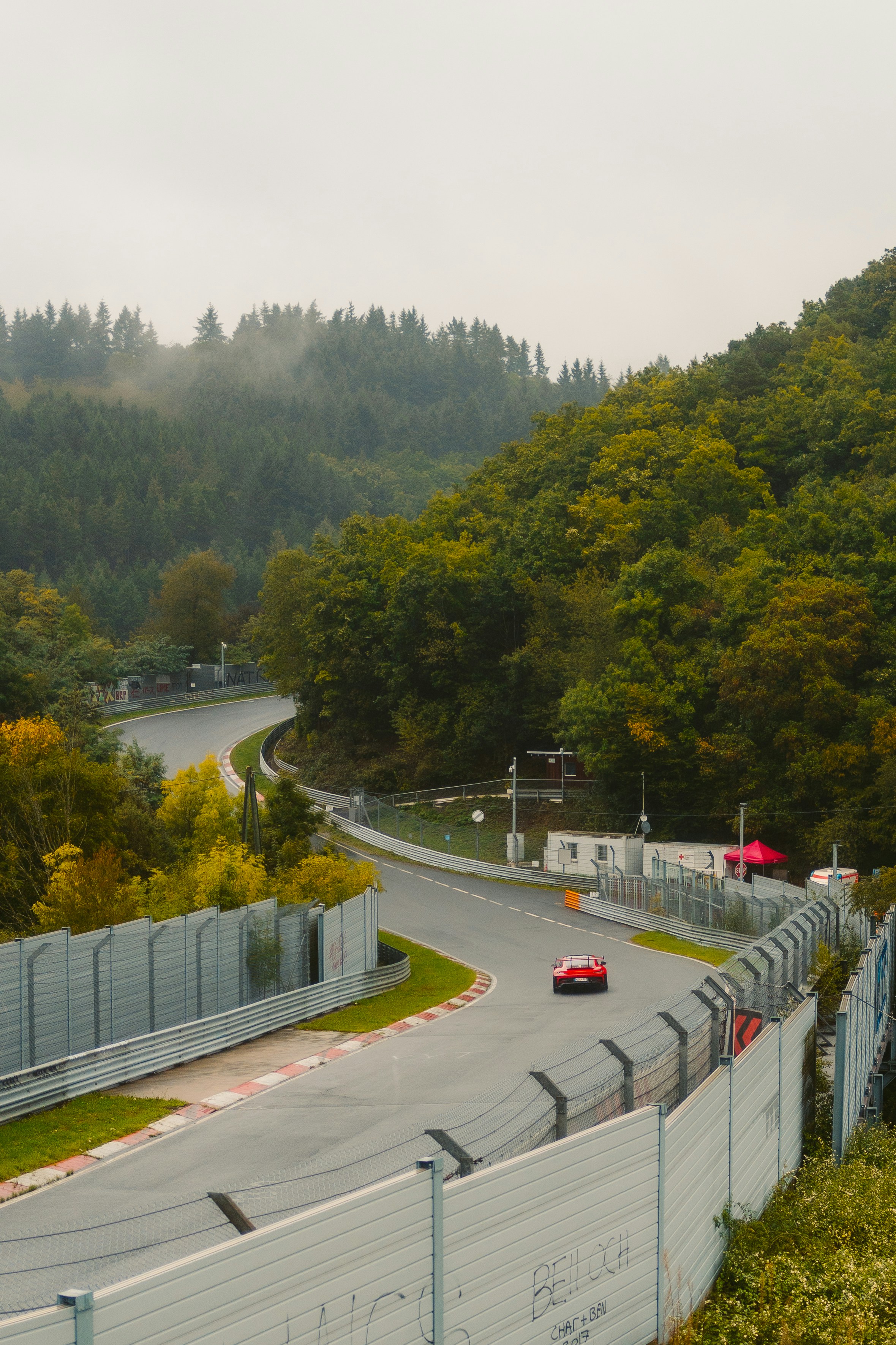 Crimson Arc: A Red Sports Car Winds Through an Autumn Hairpin