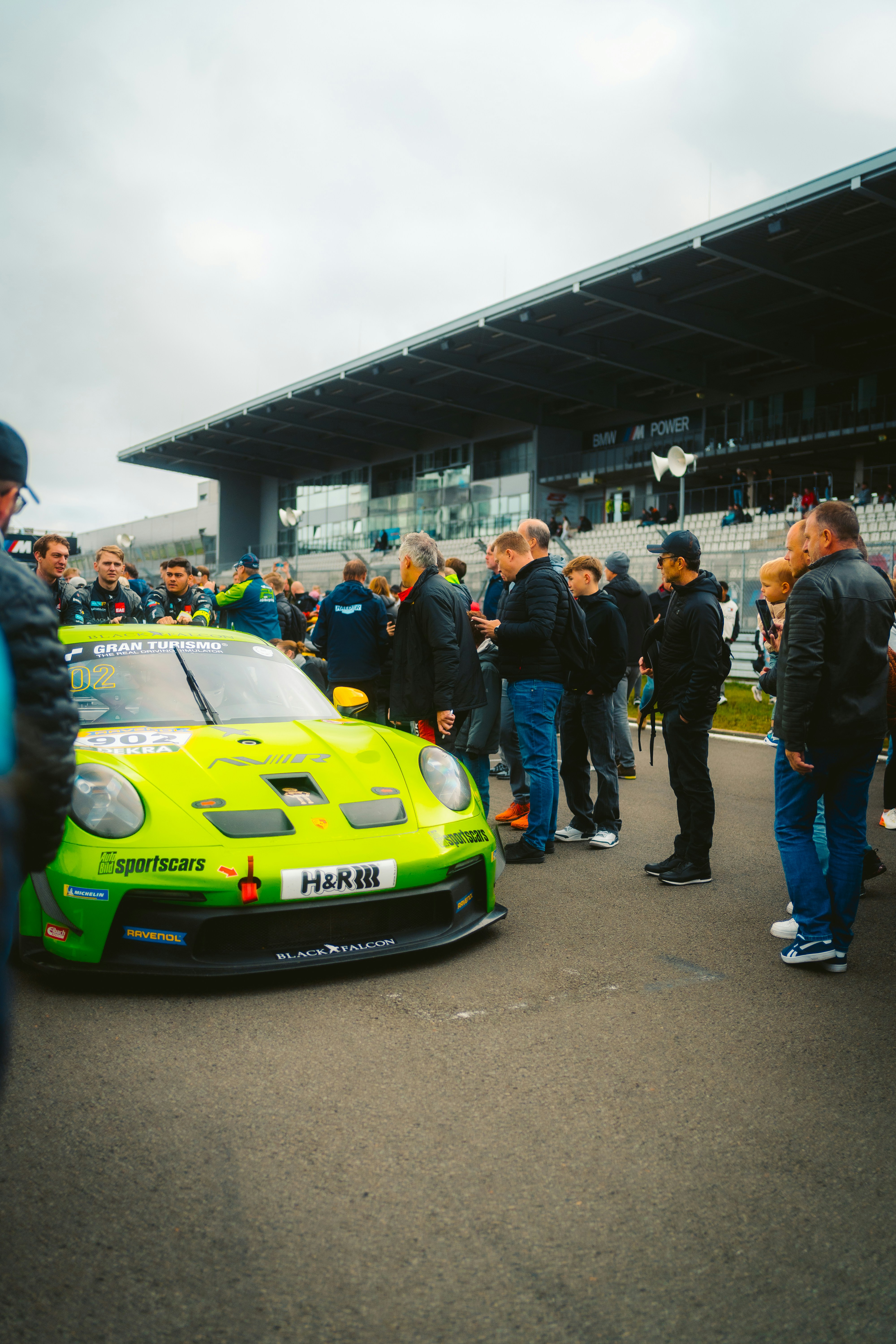 Racing Enthusiasts Gather Around the Green Machine