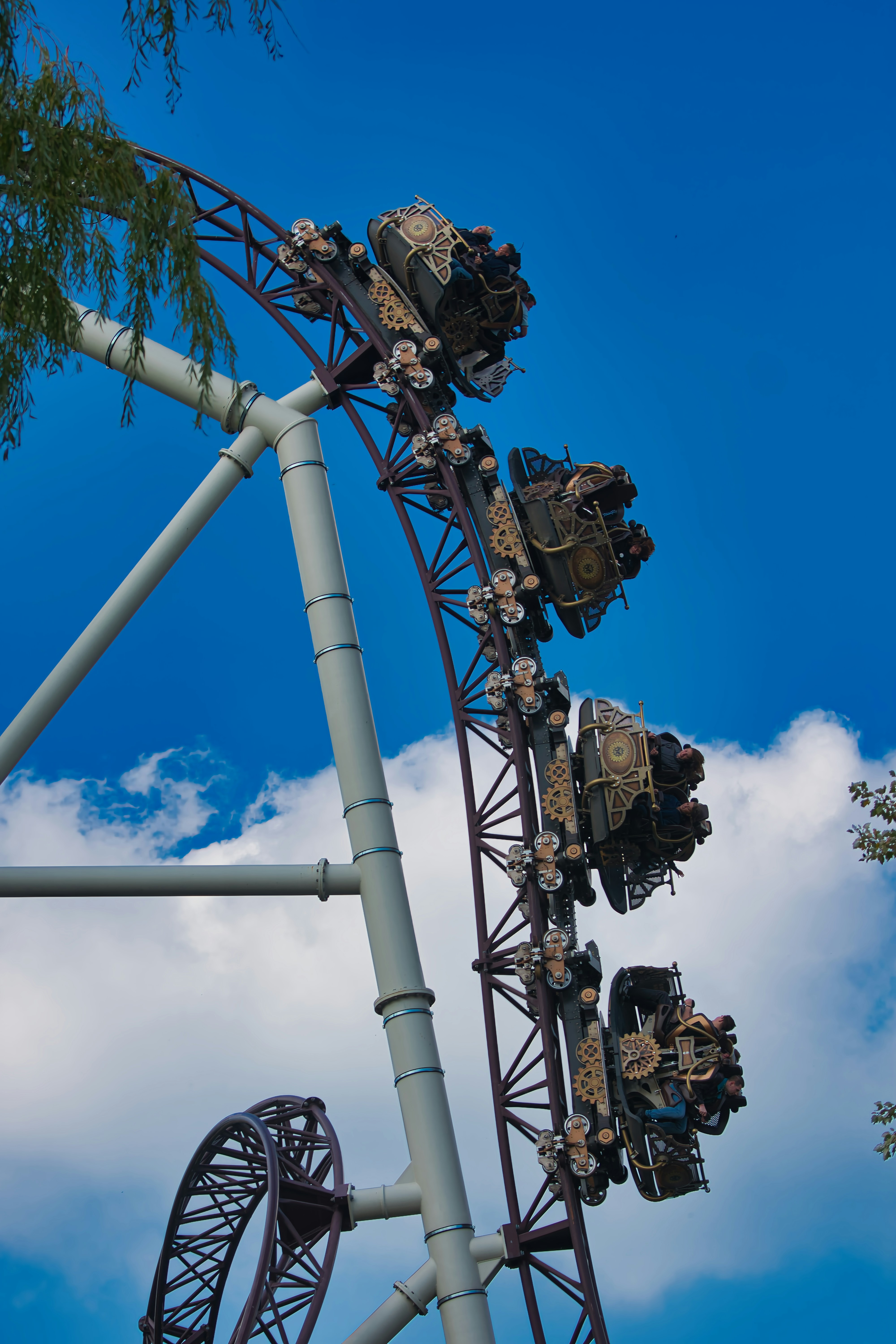 Arc of Steel: A Roller Coaster's Car Circuit Against a Clear Blue Sky