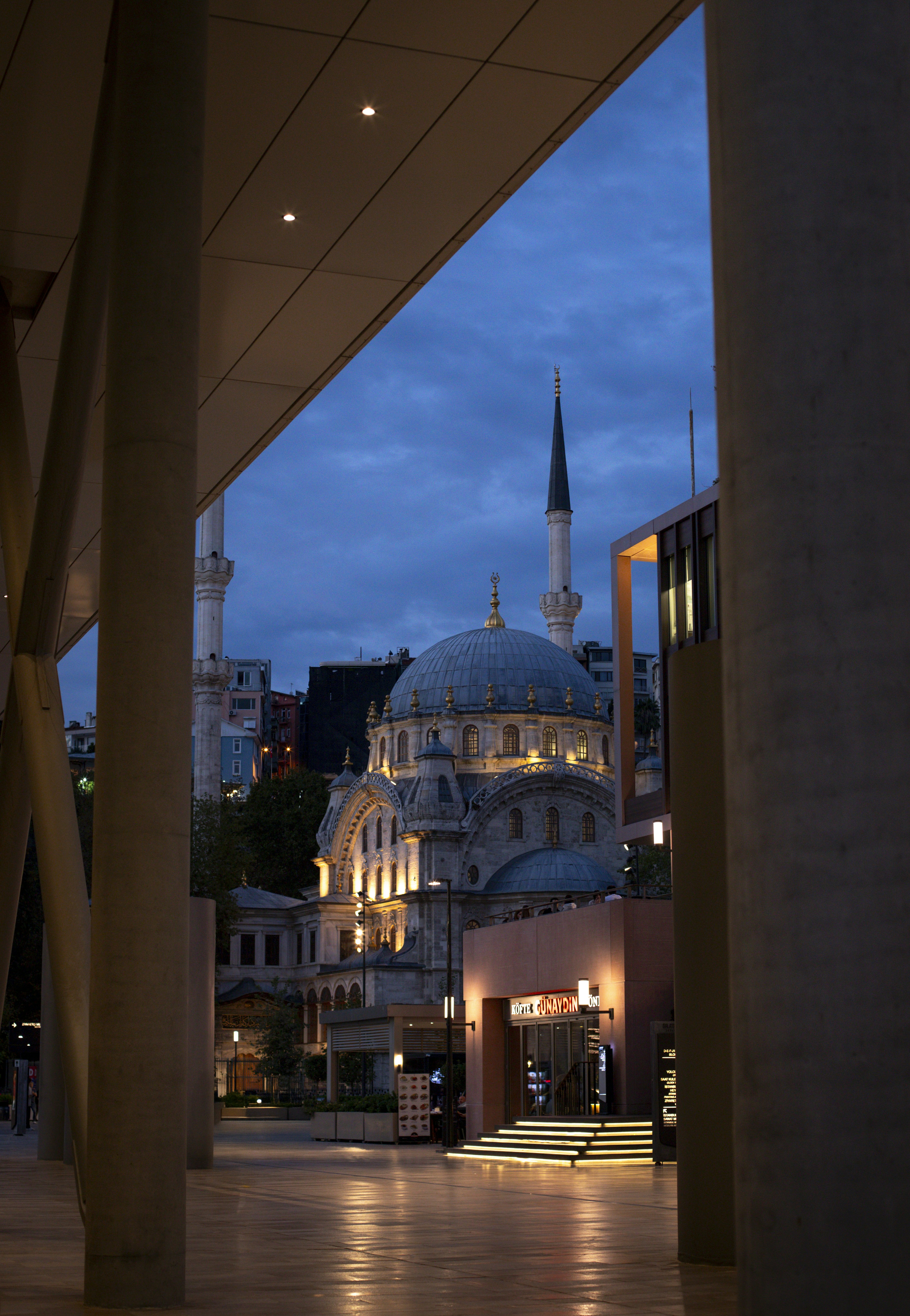 istanbul | Illuminated mosque with minarets at dusk.