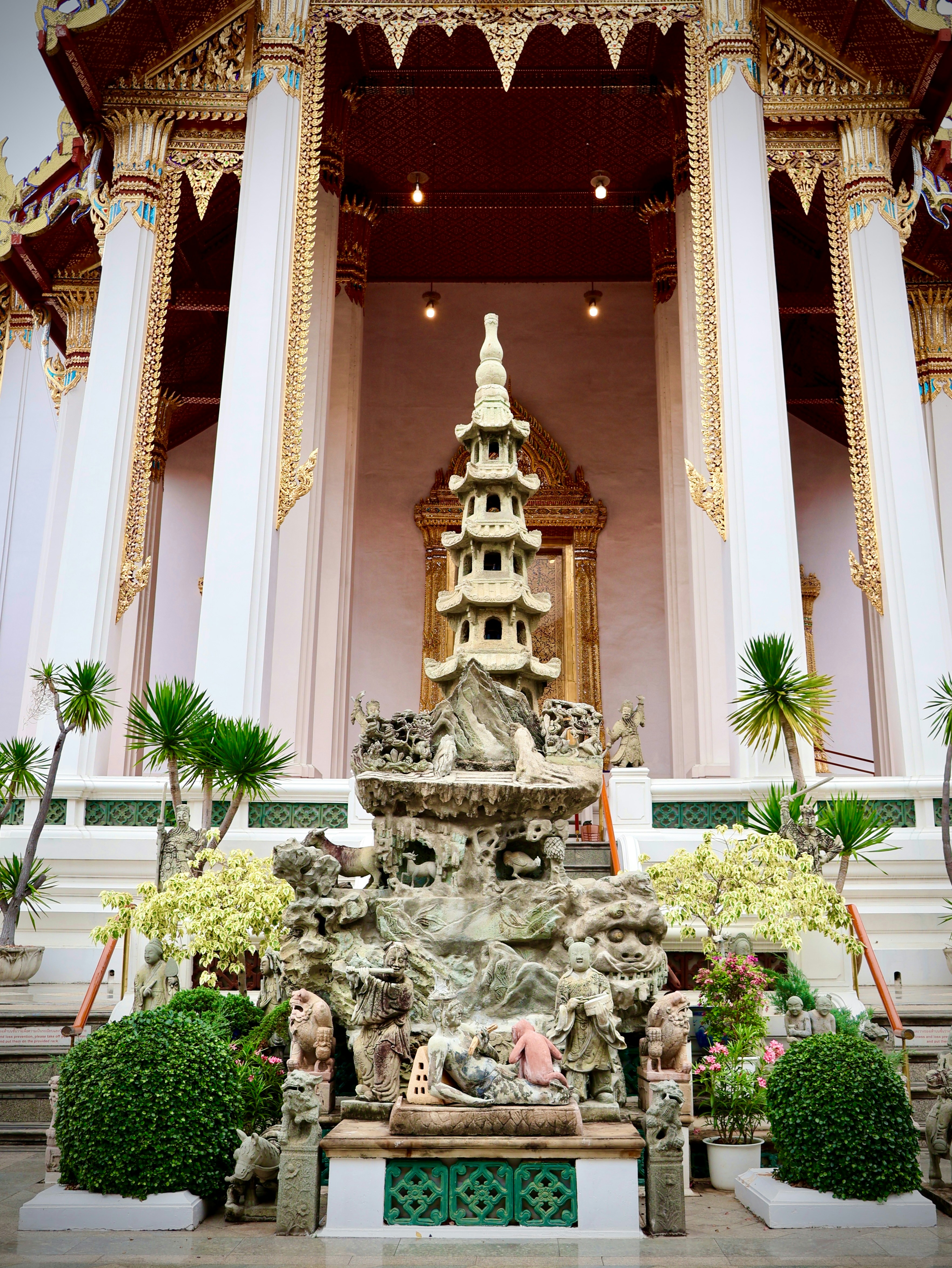 Ornate stone shrine with reclining buddha statue.