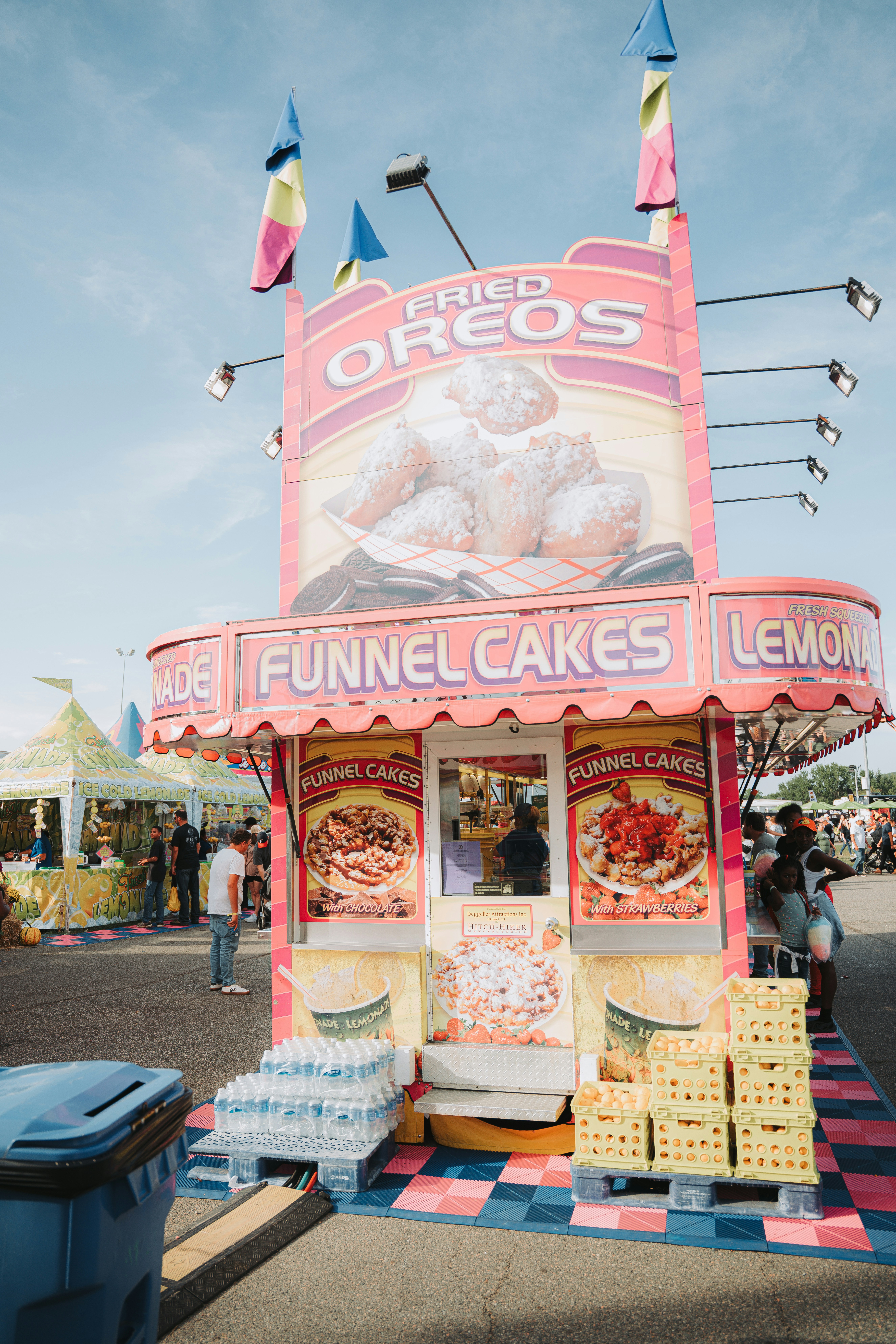 Fried oreos and funnel cake stand at an outdoor fair