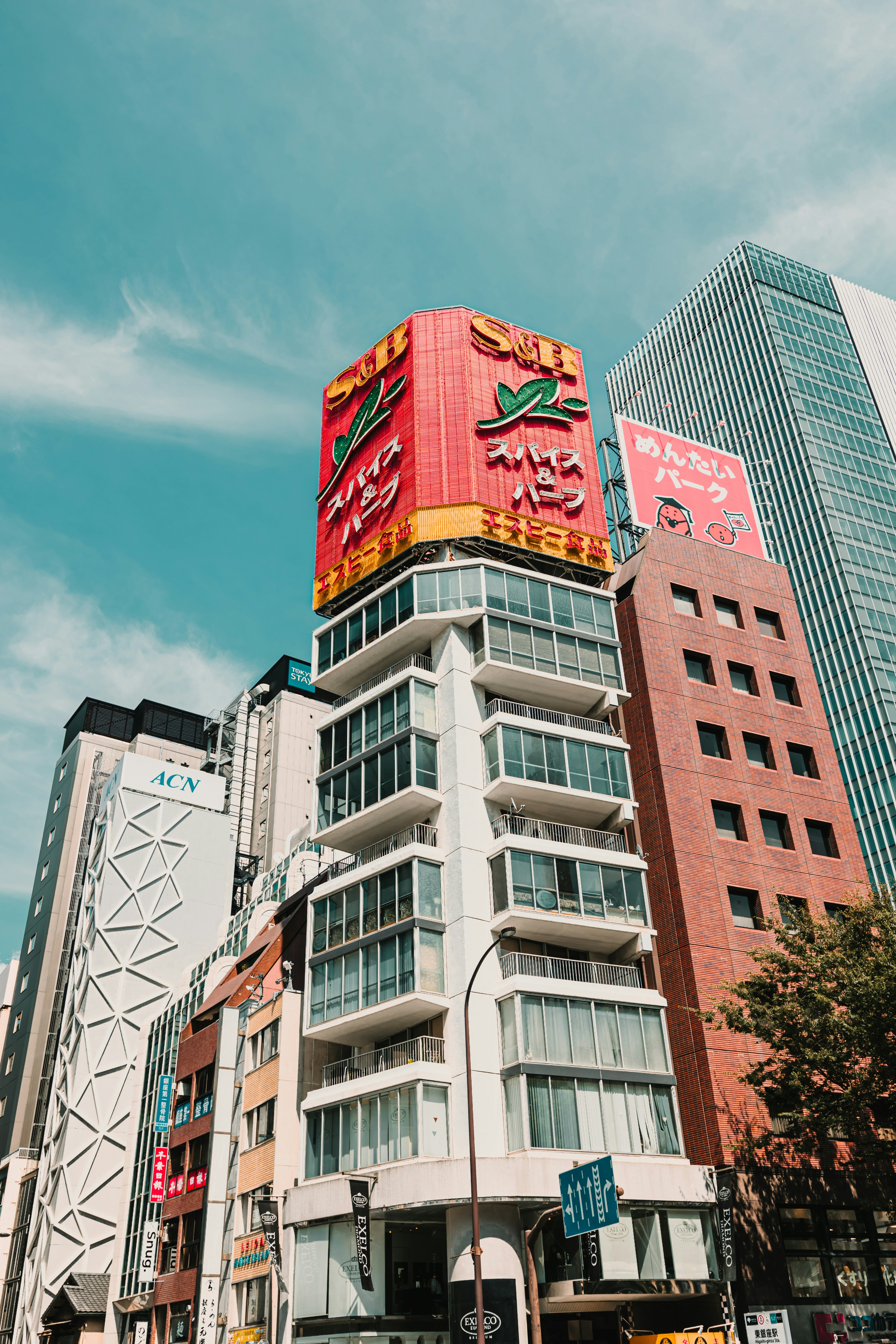 Modern buildings with a large red sign.