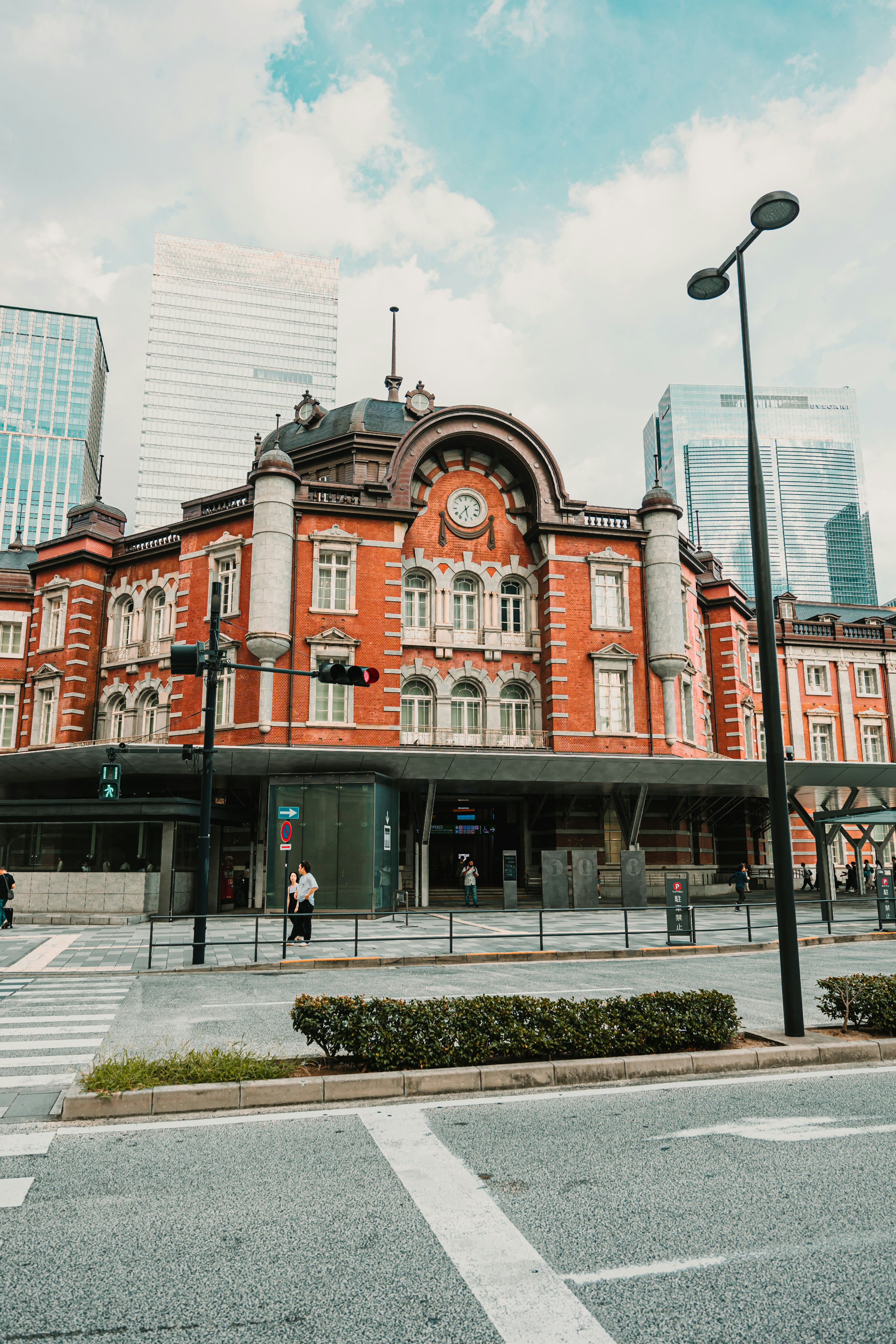 Tokyo Station's Red-Brick Clocktower Rising Amid a Modern Glass Skyline