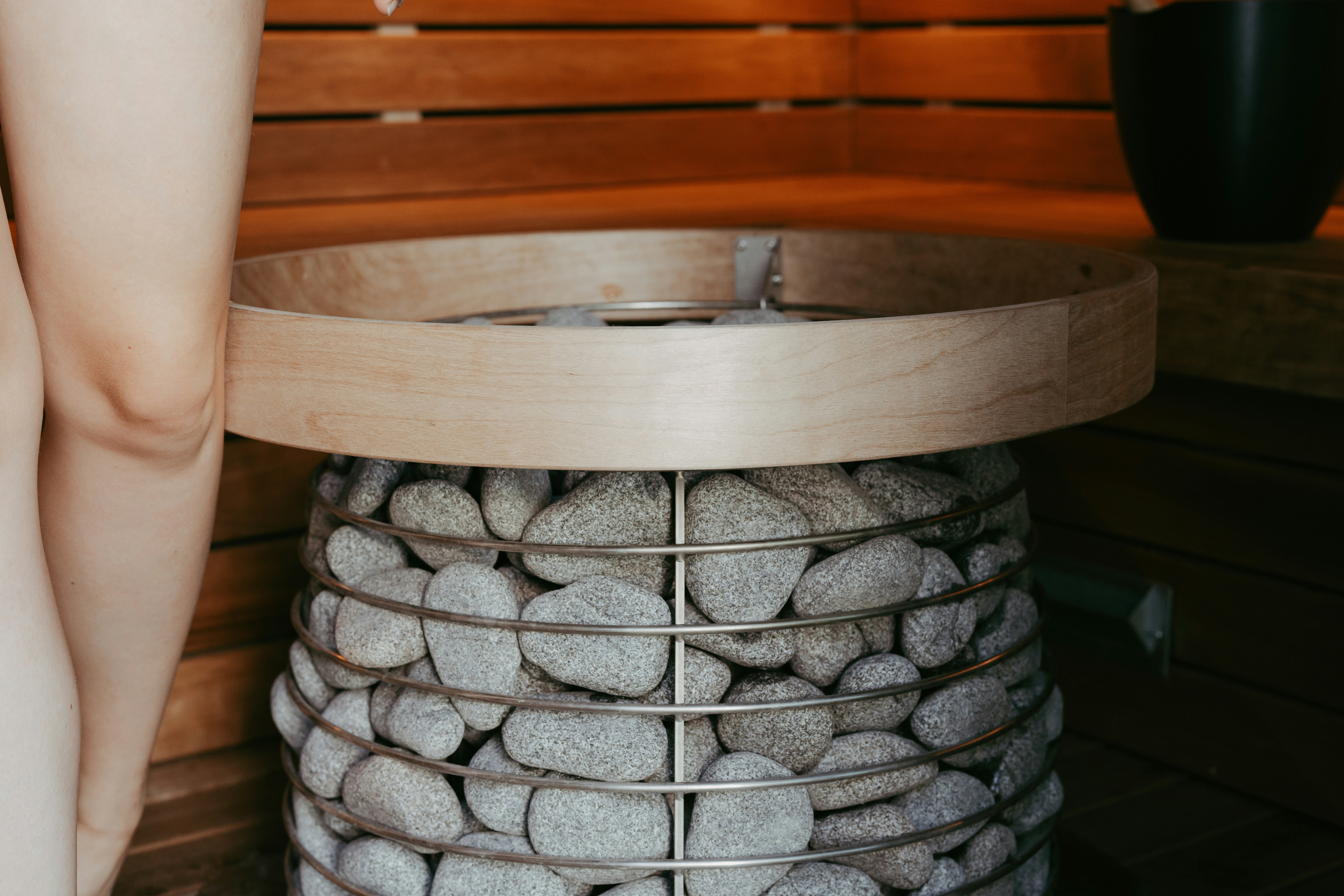 Sauna heater with stones and wooden walls