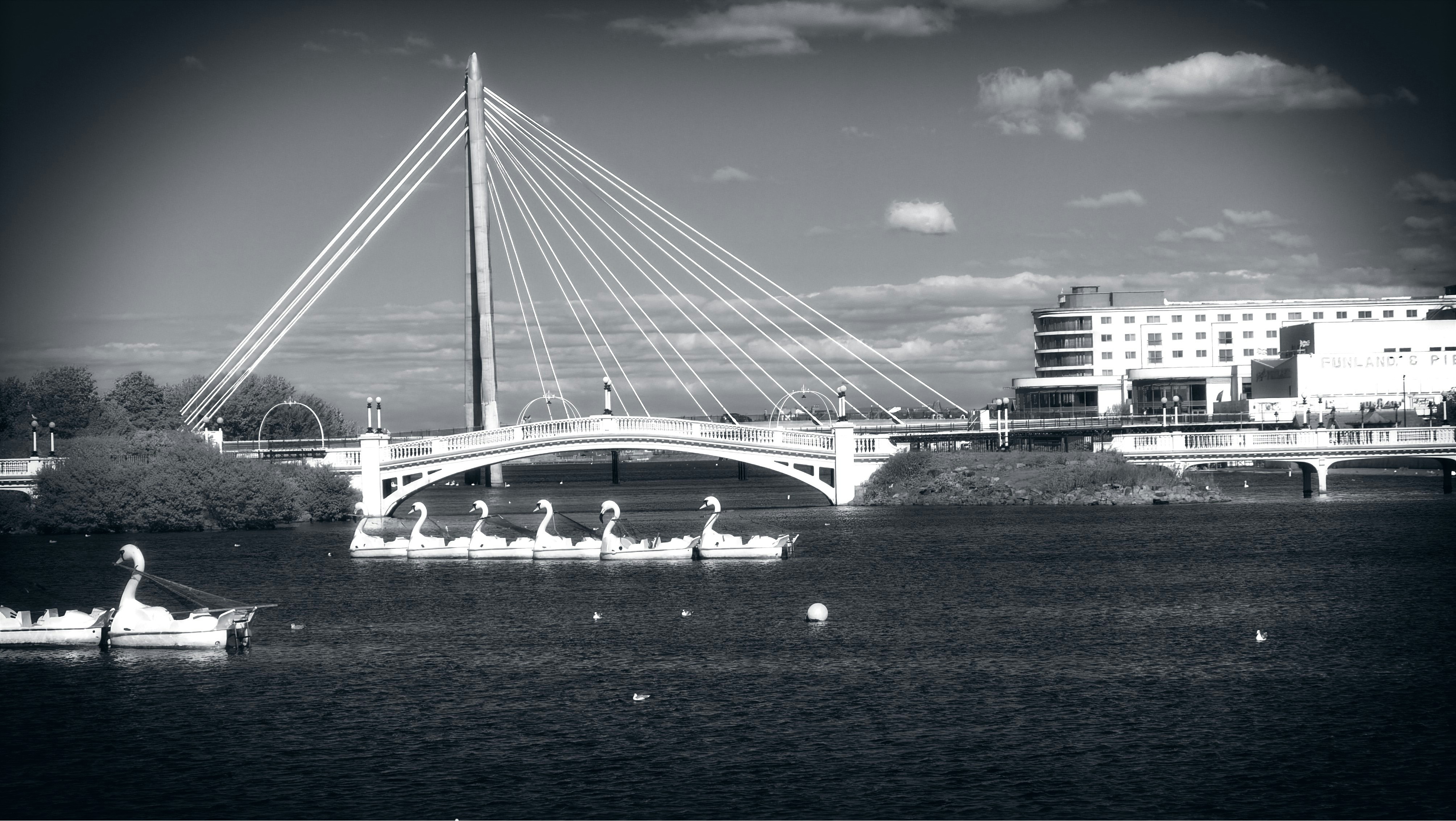 A photo walk through the historic Victorian gardens in Southport England. Images taken with a LUMIX G10 converted to full spectrum infrared. | Modern bridge over a lake with swan boats