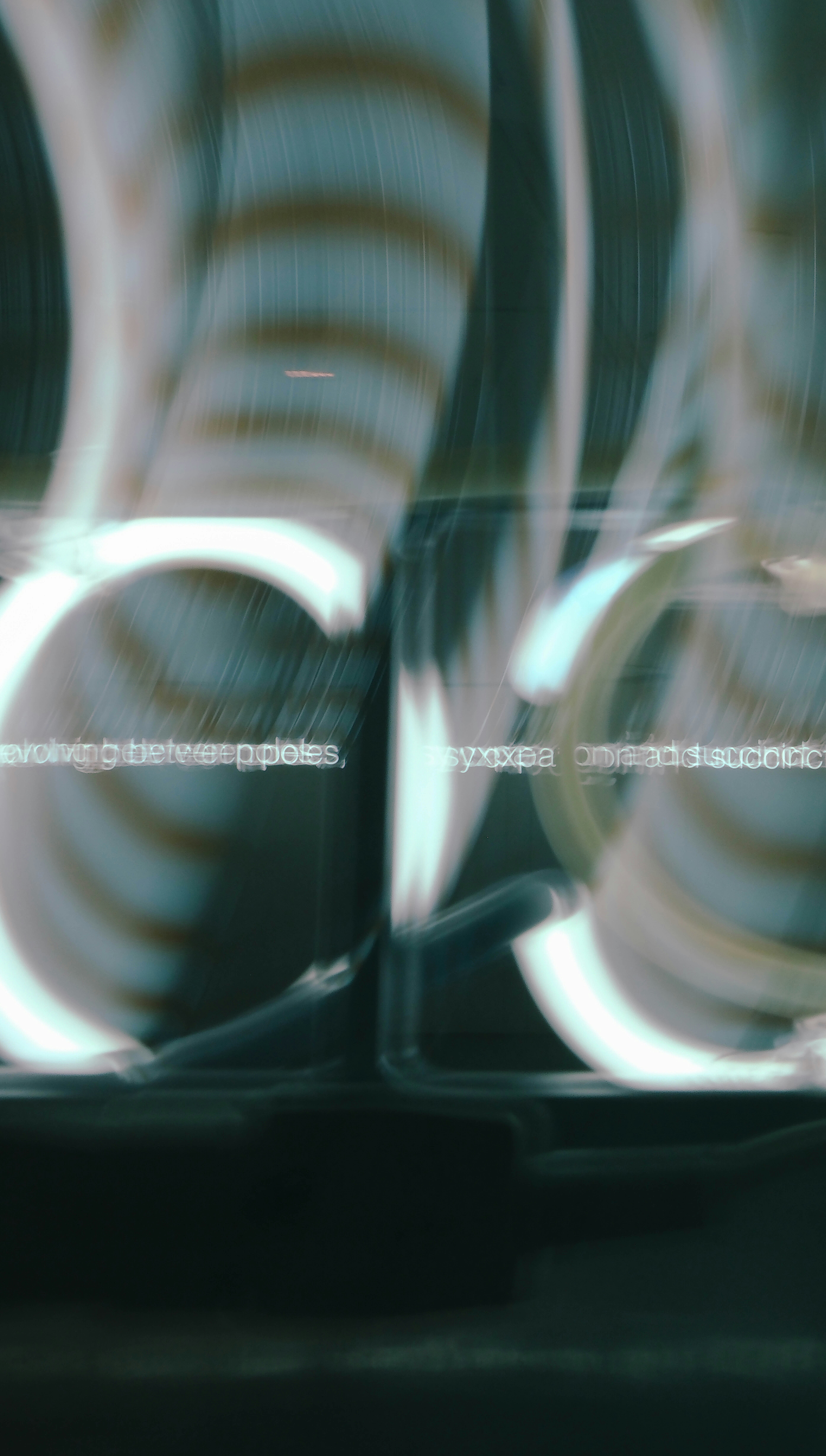 Abstract light streaks forming letters c and a shapes