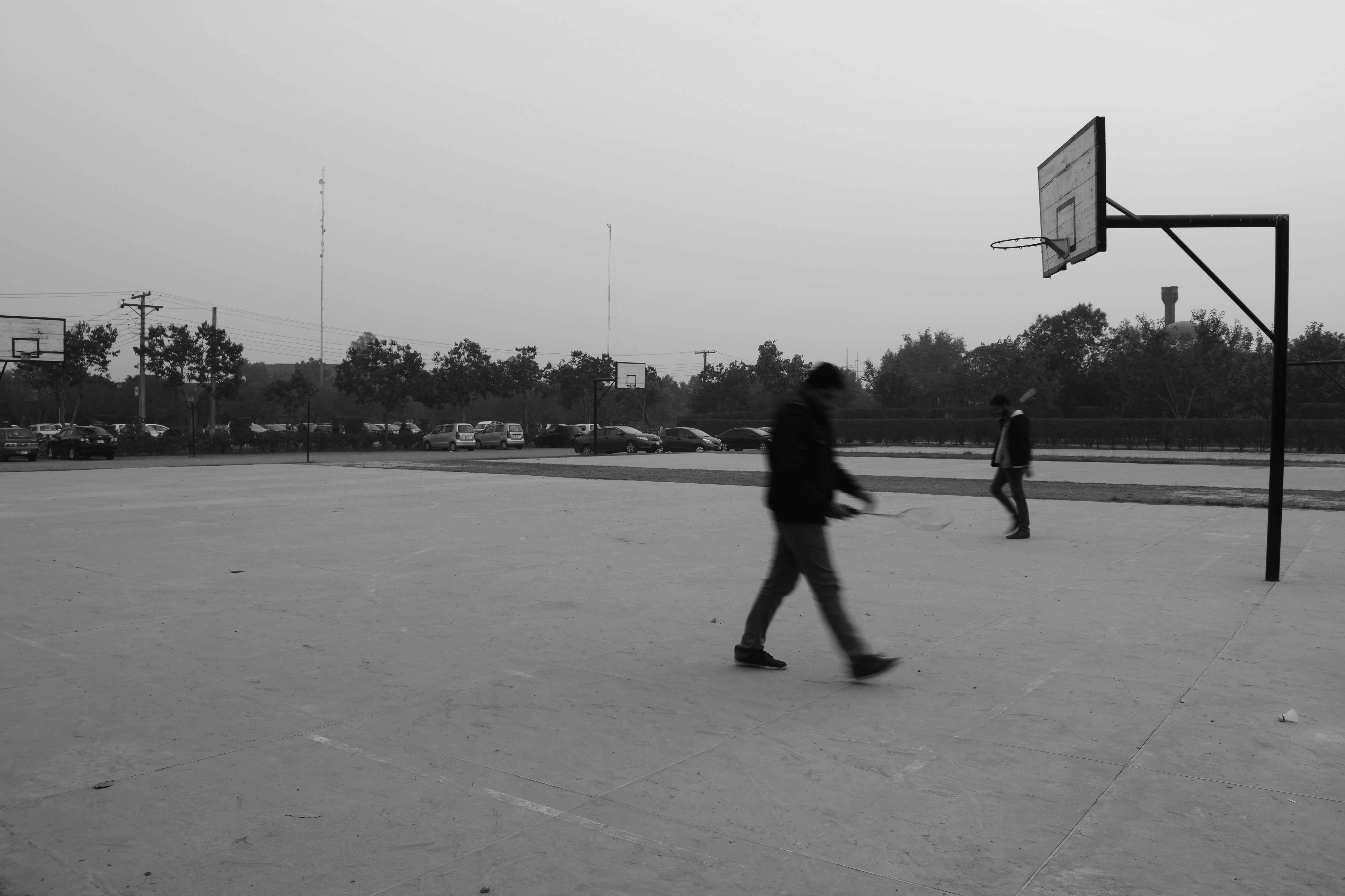 Two people on an outdoor basketball court