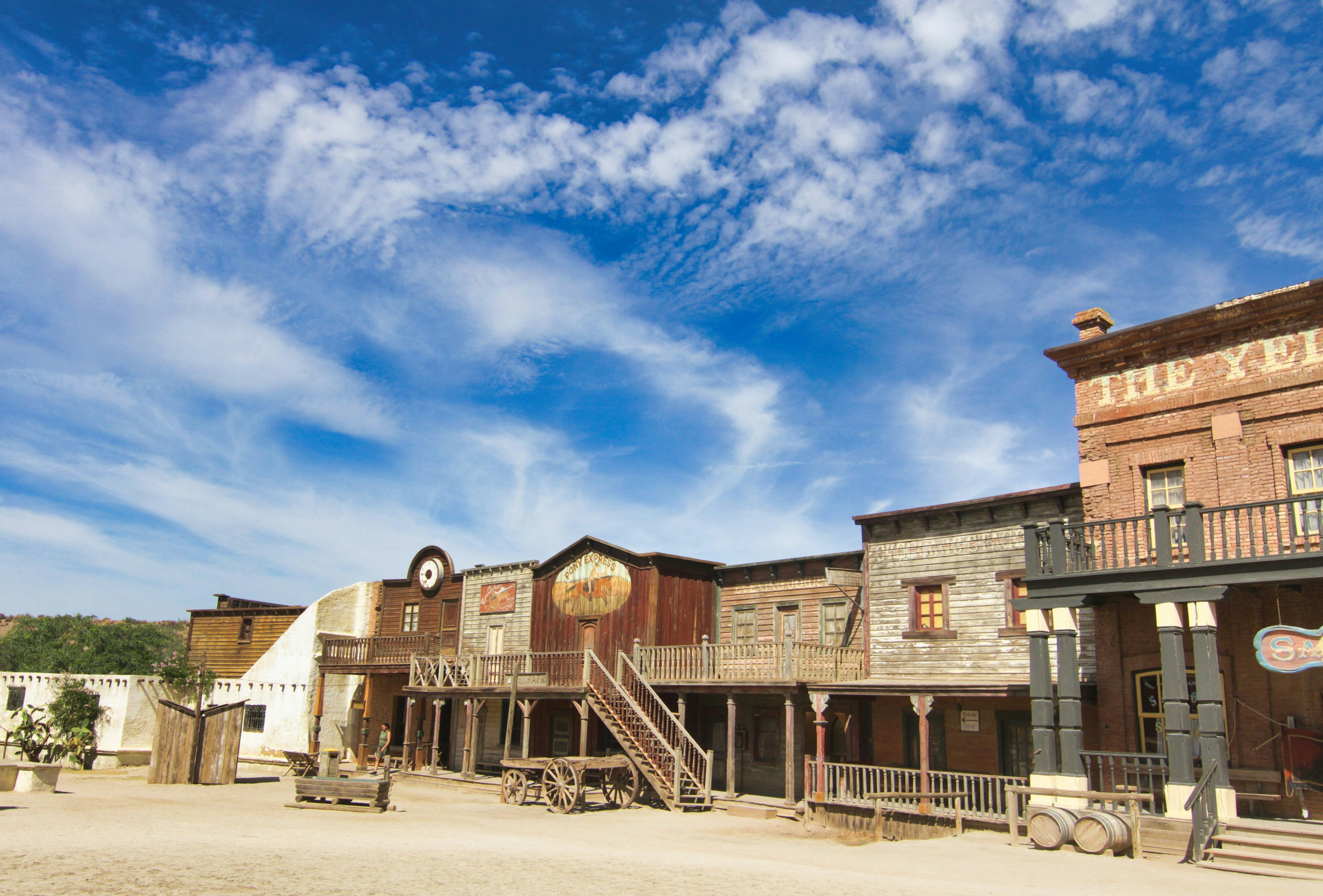 wild west town | Old western town buildings under a blue sky.