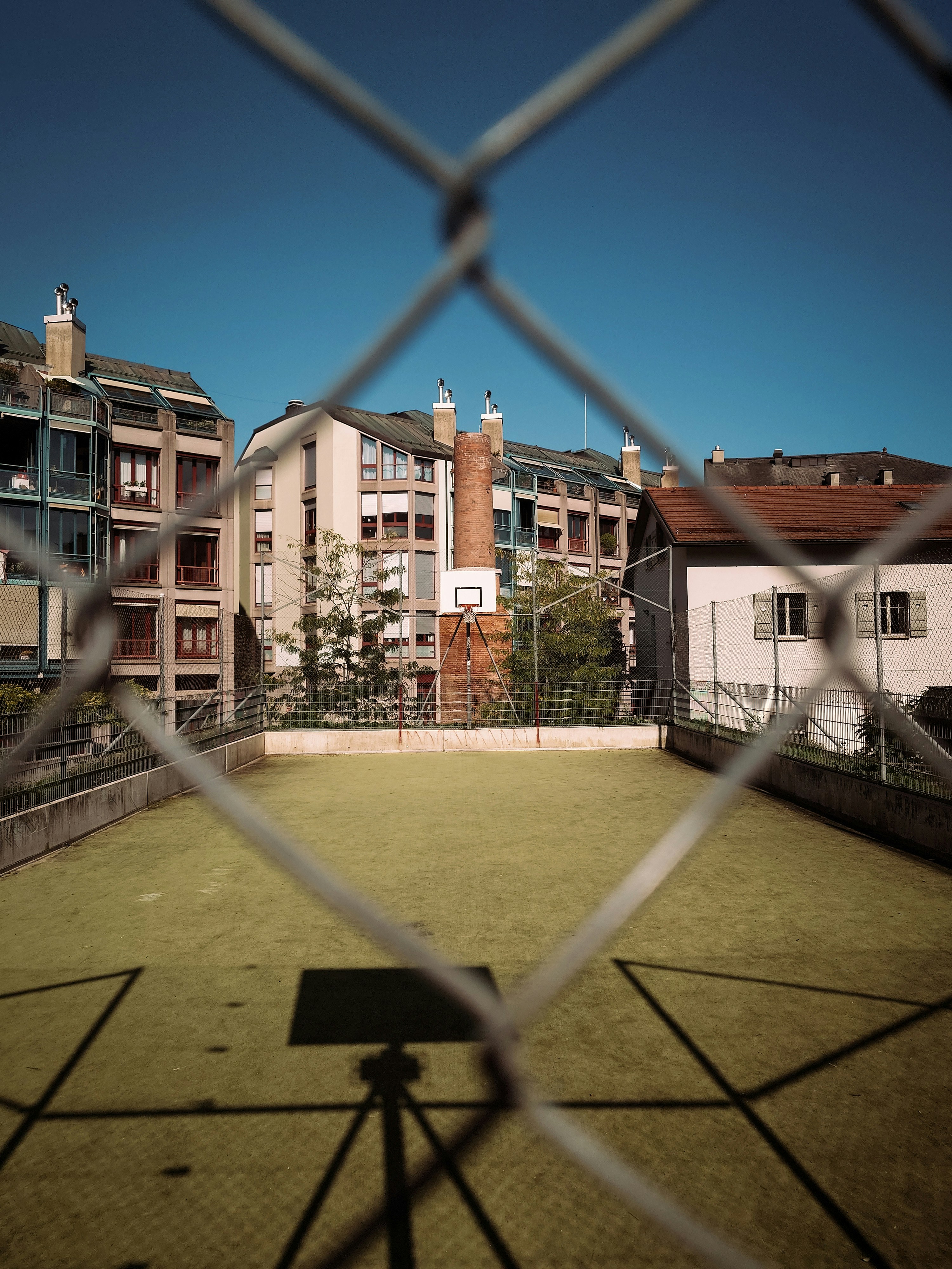Basketball court behind a chain-link fence