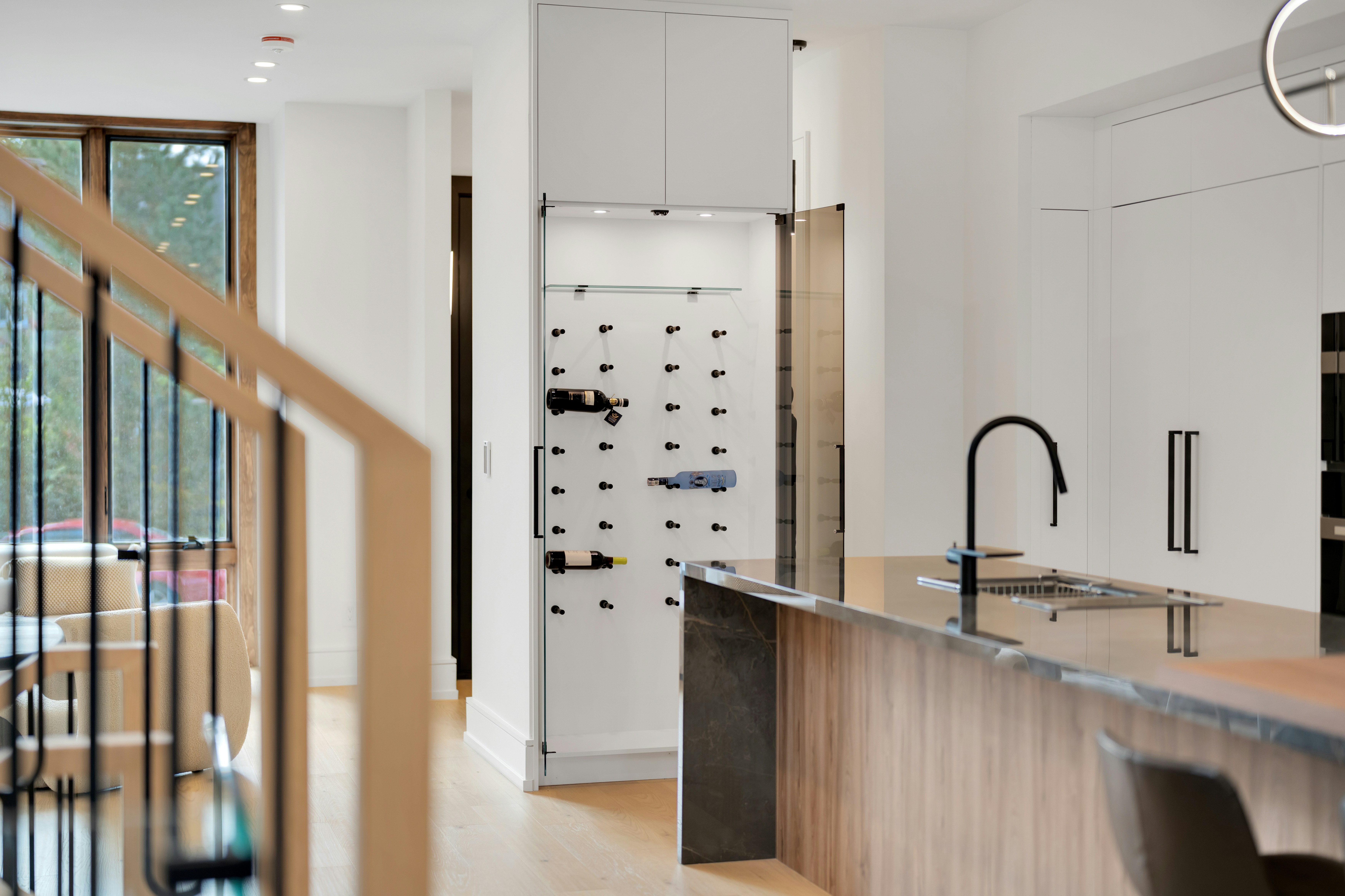 Modern kitchen with wine rack and island.
