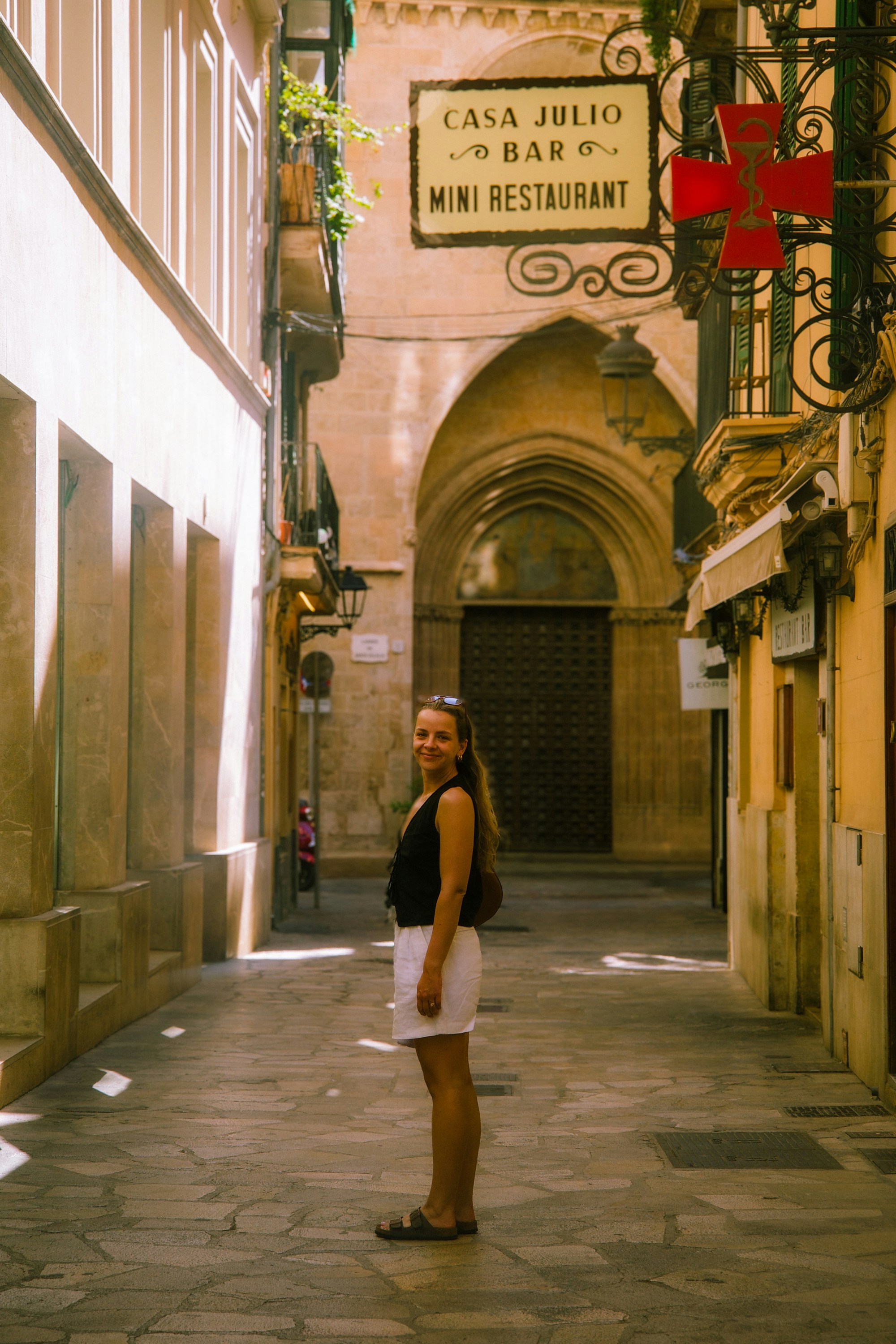 Woman standing in a narrow european street.