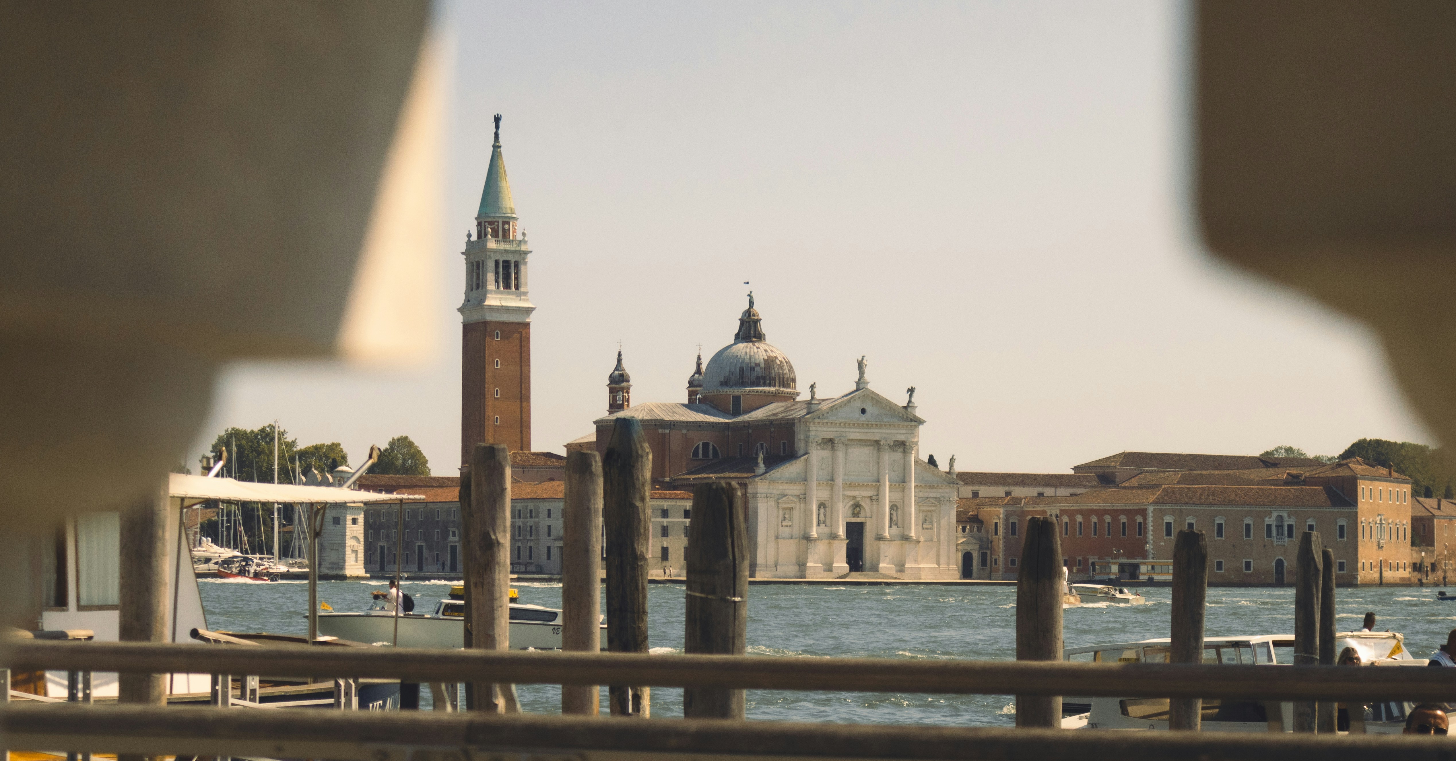 Buildings and canal in venice with boats on water.