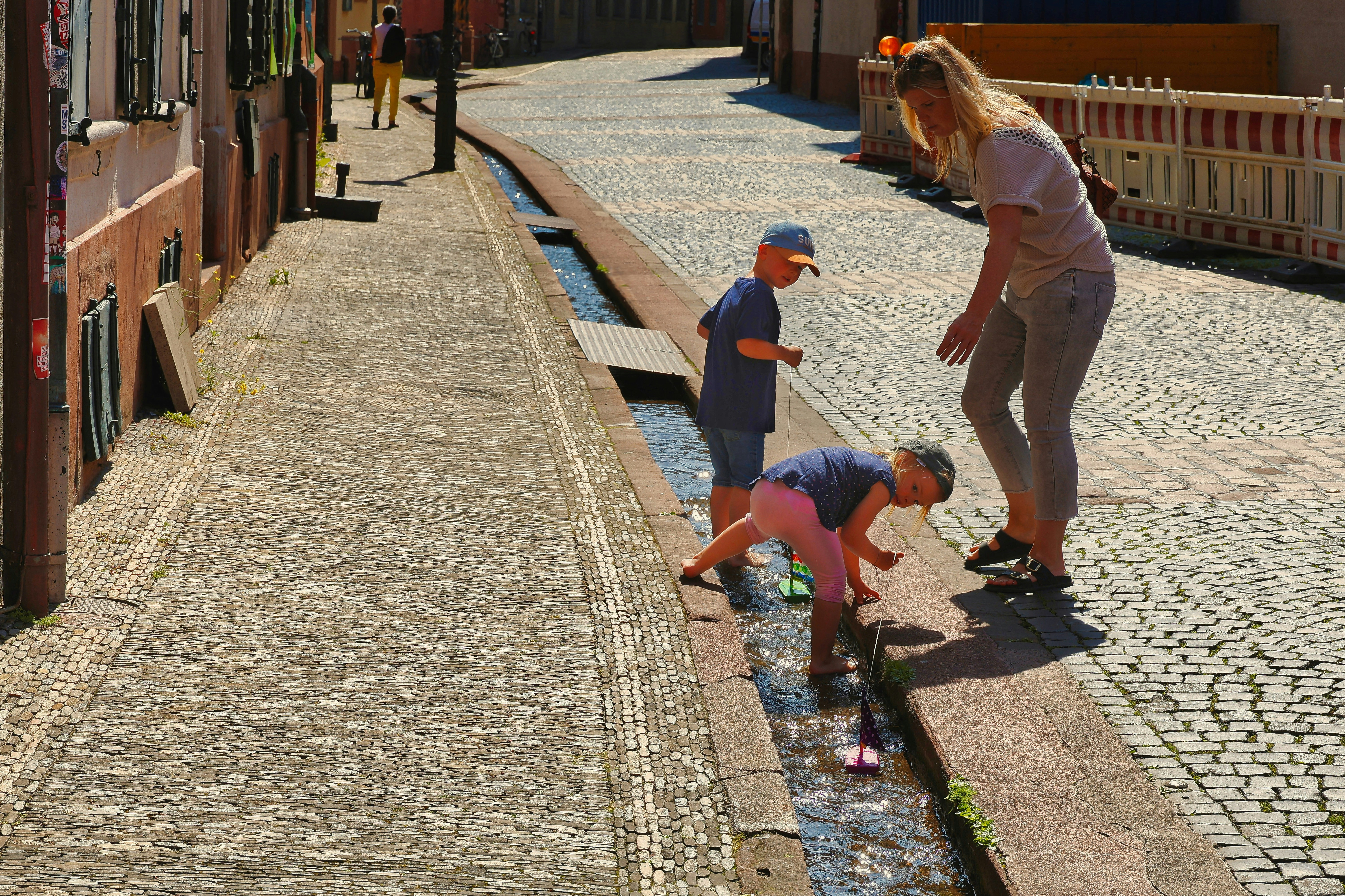 Woman and children play in a small stream. photo – Free Woman Image on ...