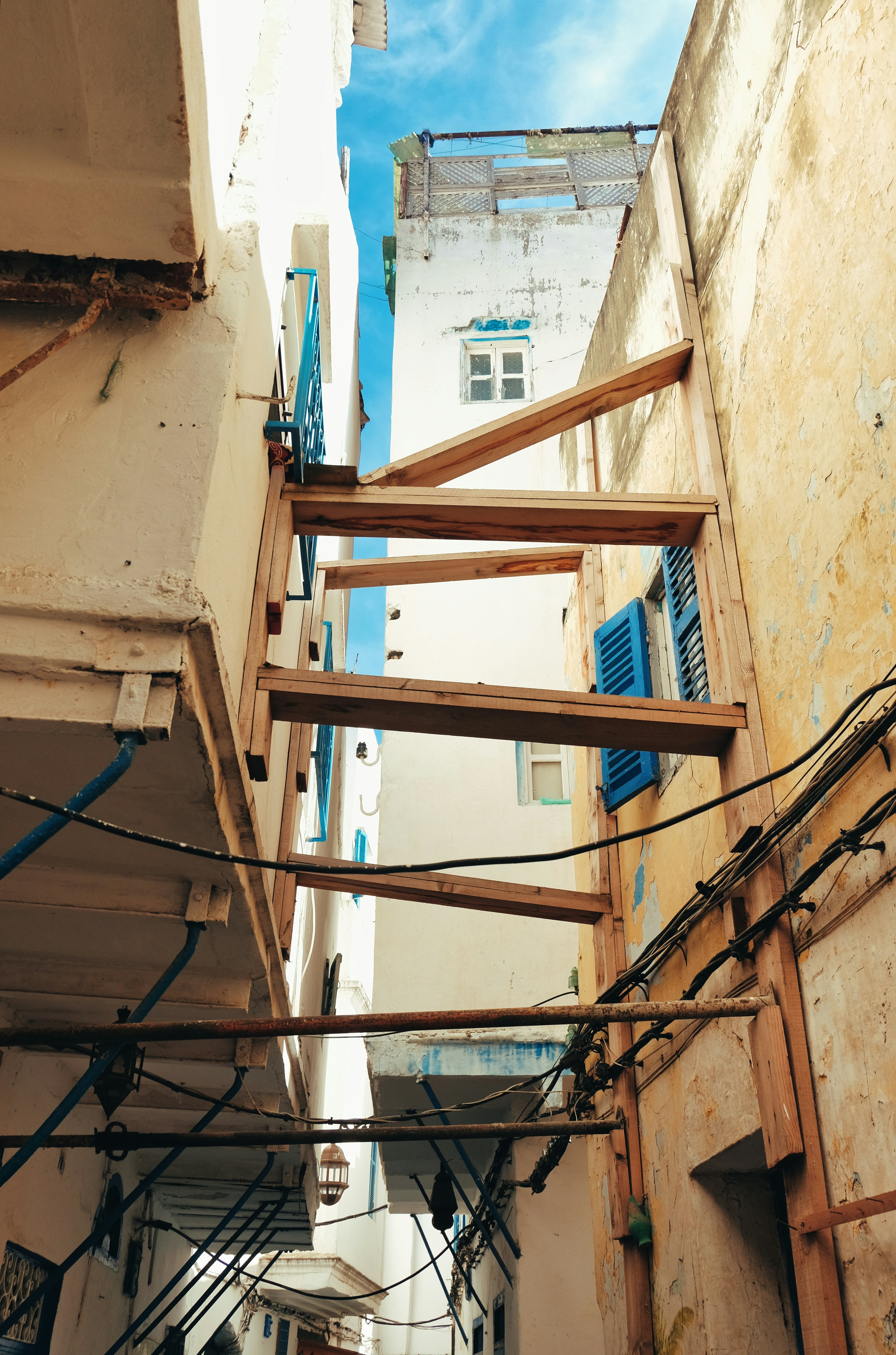 Bridging the Urban Divide: A Wooden Pathway Amongst the Walls