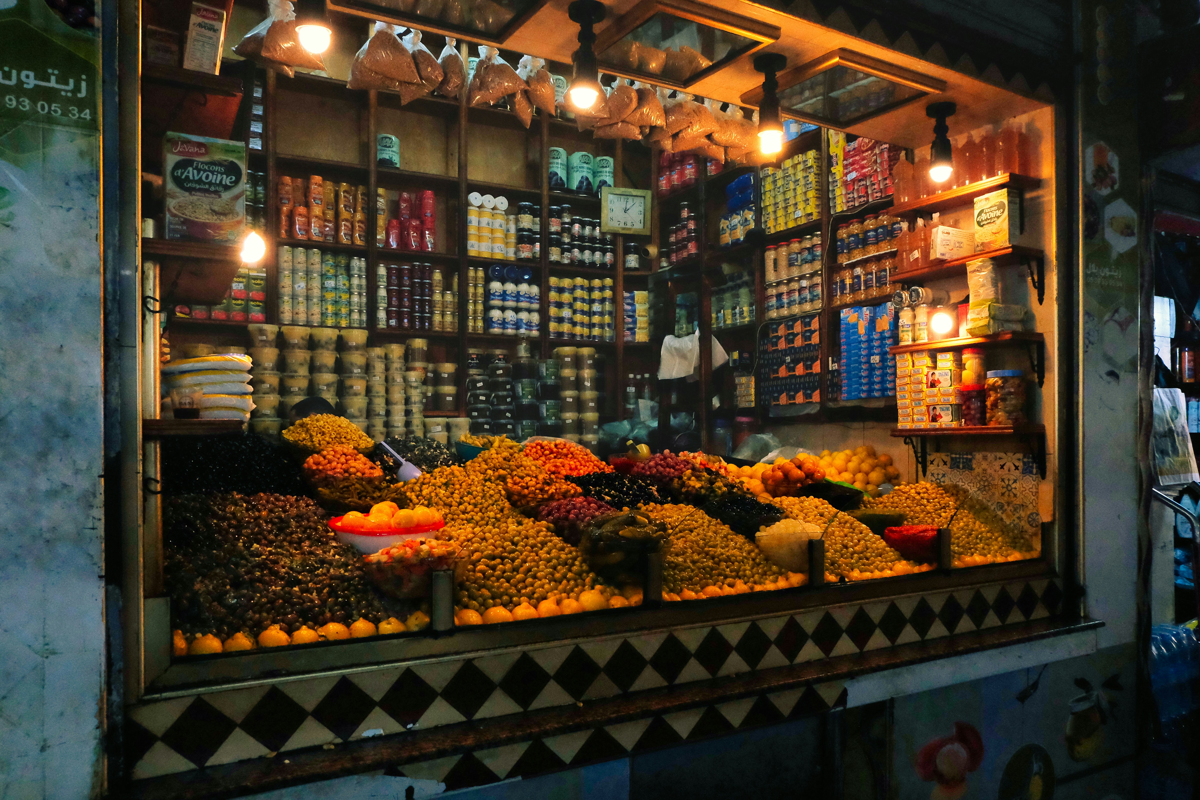 A colorful market stall overflowing with dried fruits and nuts.