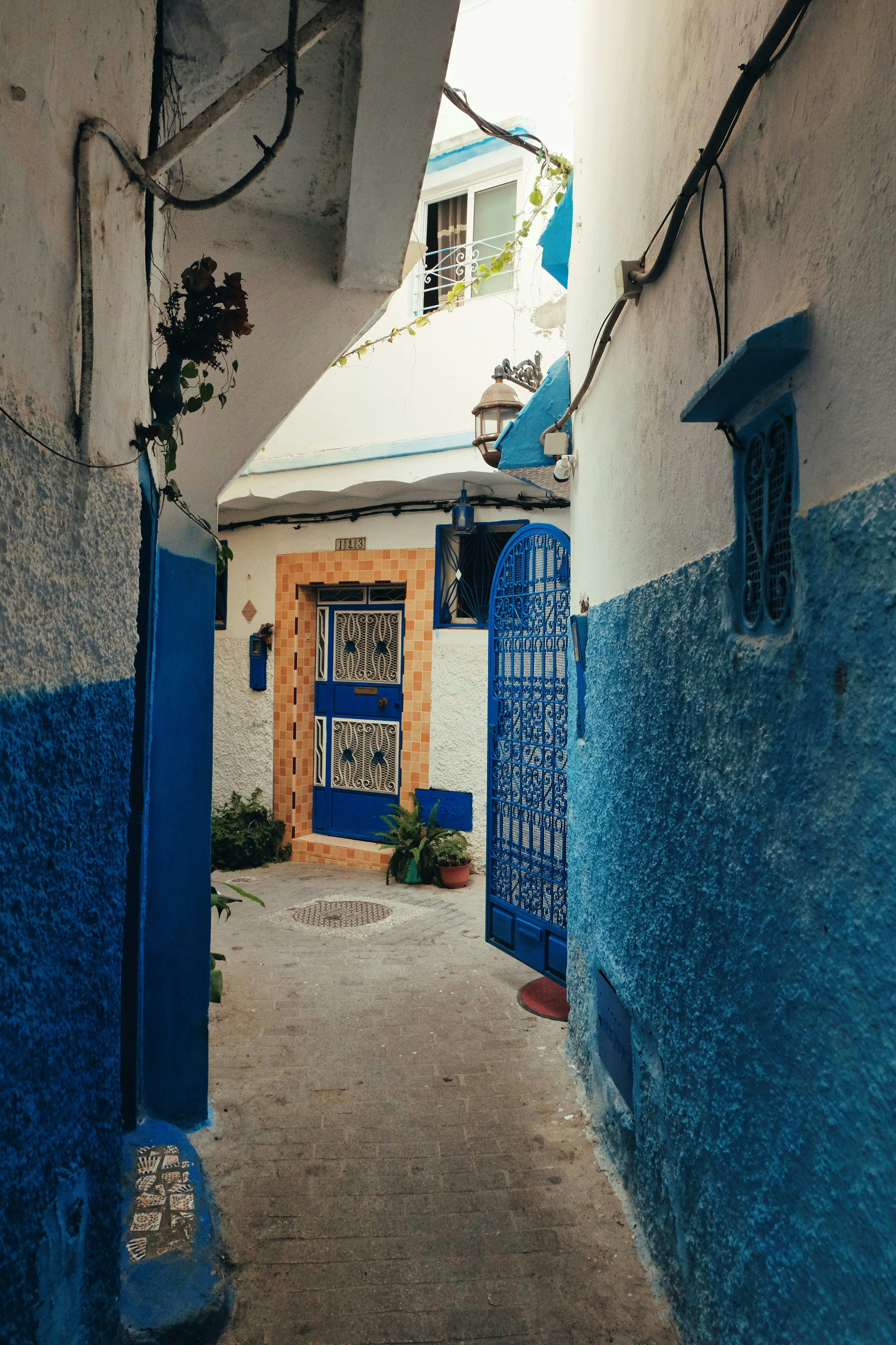 Narrow alleyway with blue and white buildings photo – Free Architecture ...