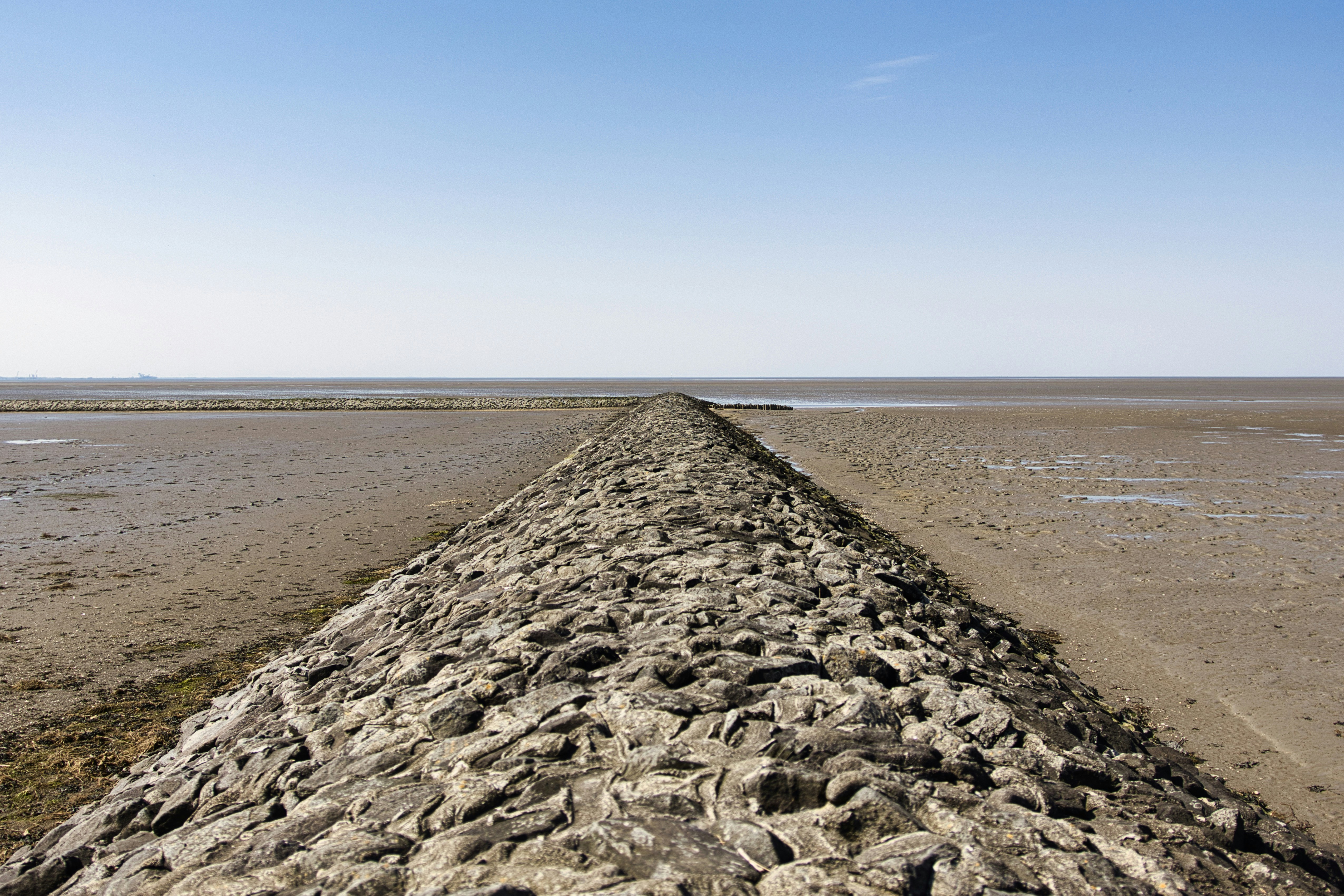 Stone Breakwater Reaches Toward a Quiet Horizon