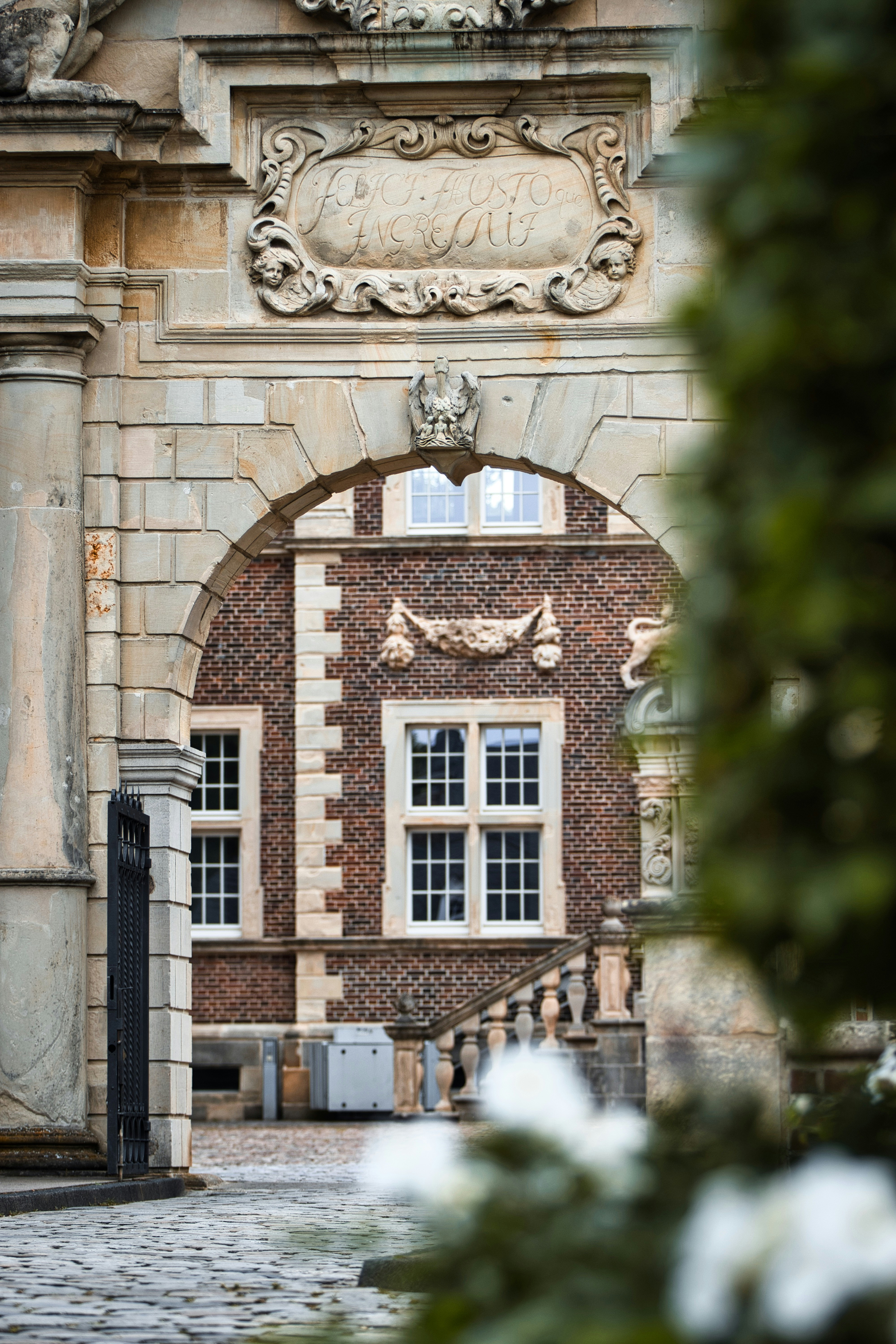 Frame Within a Frame: Stone Arch Framing a Brick Courtyard