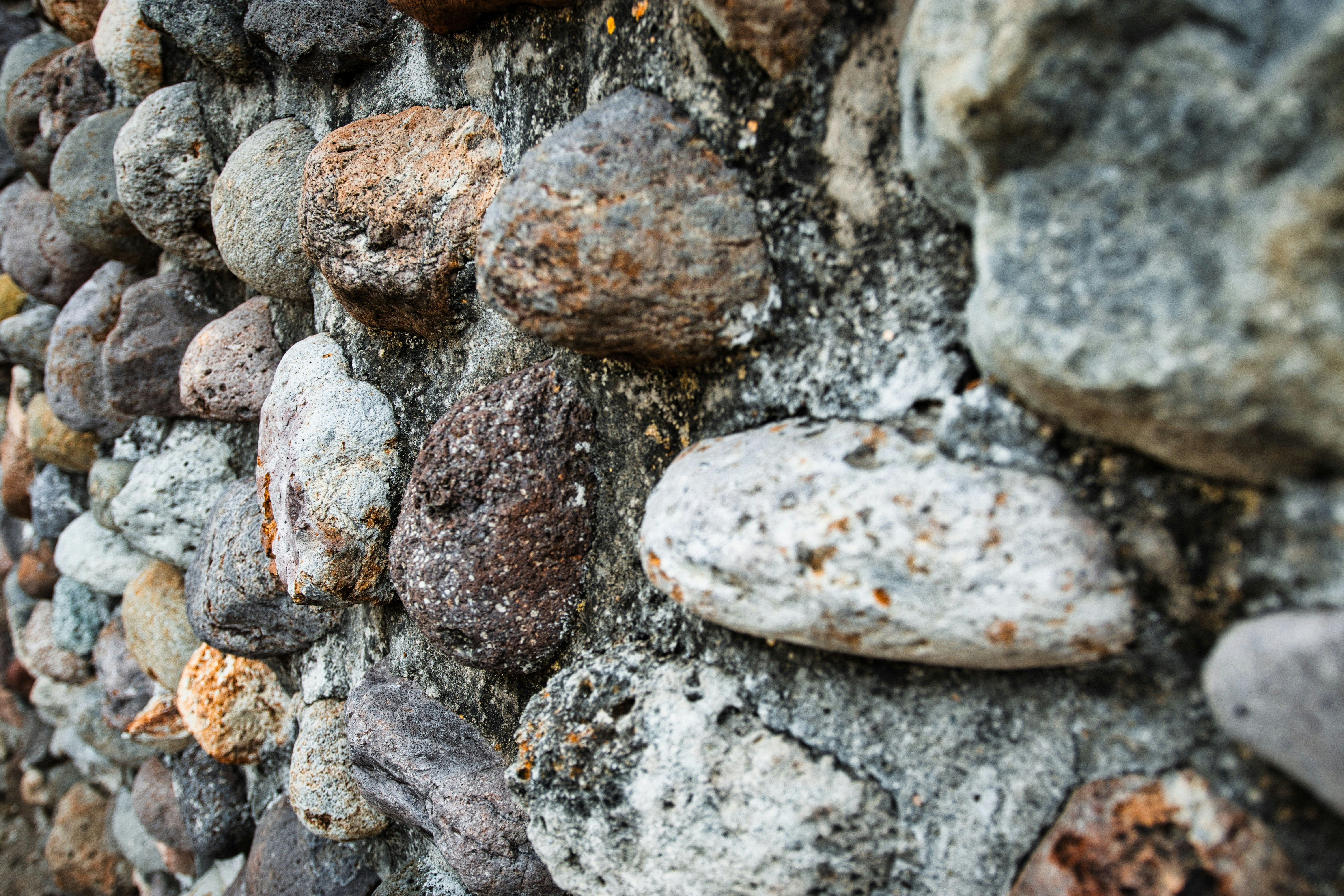 Close-up of a textured stone wall with mortar wall