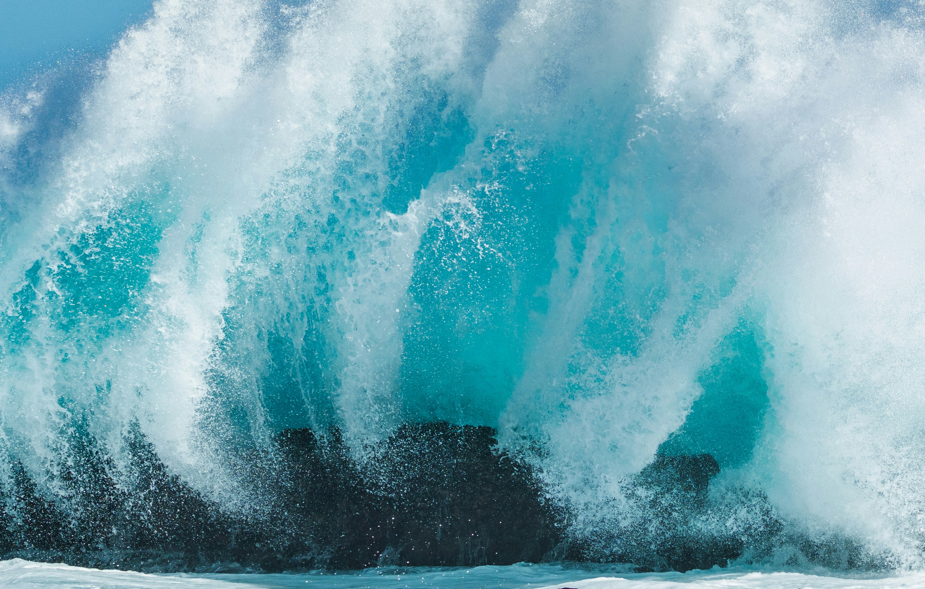 Turquoise Wall Unfolds: A Wave Breaks into Foam
