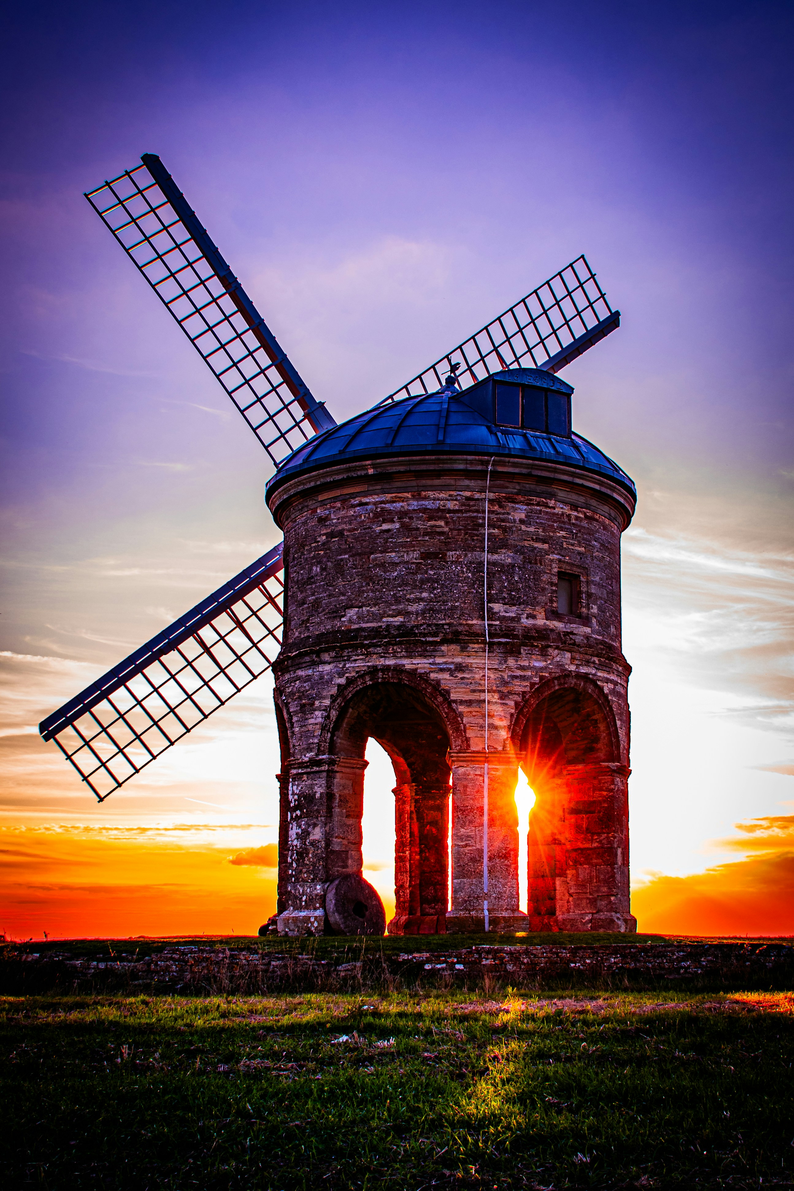 Golden Hour sunset at Chesterton Windmill, Leamington Spa UK | Stone windmill silhouetted against a vibrant sunset sky.