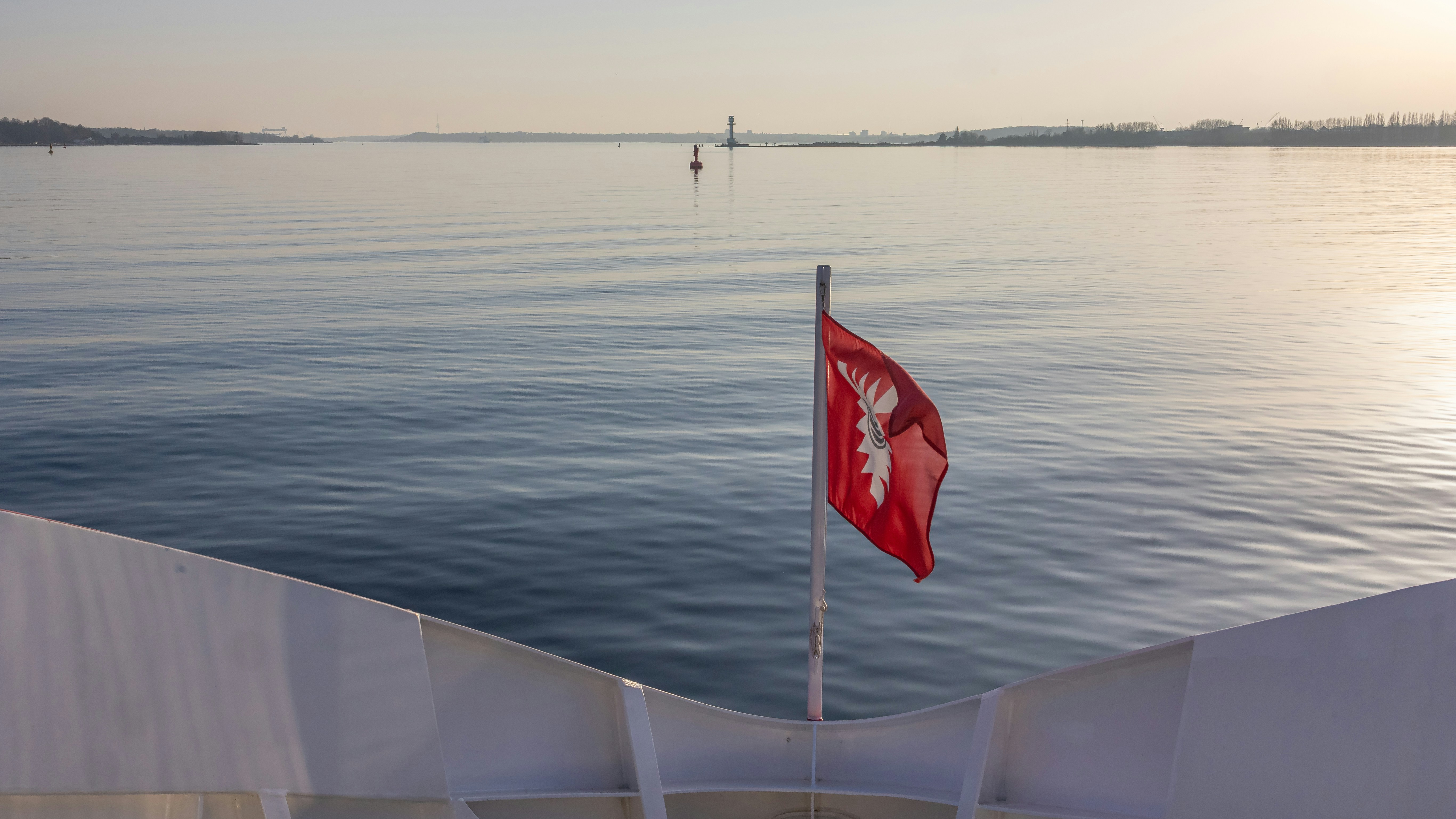 Red flag on a boat sailing on calm water
