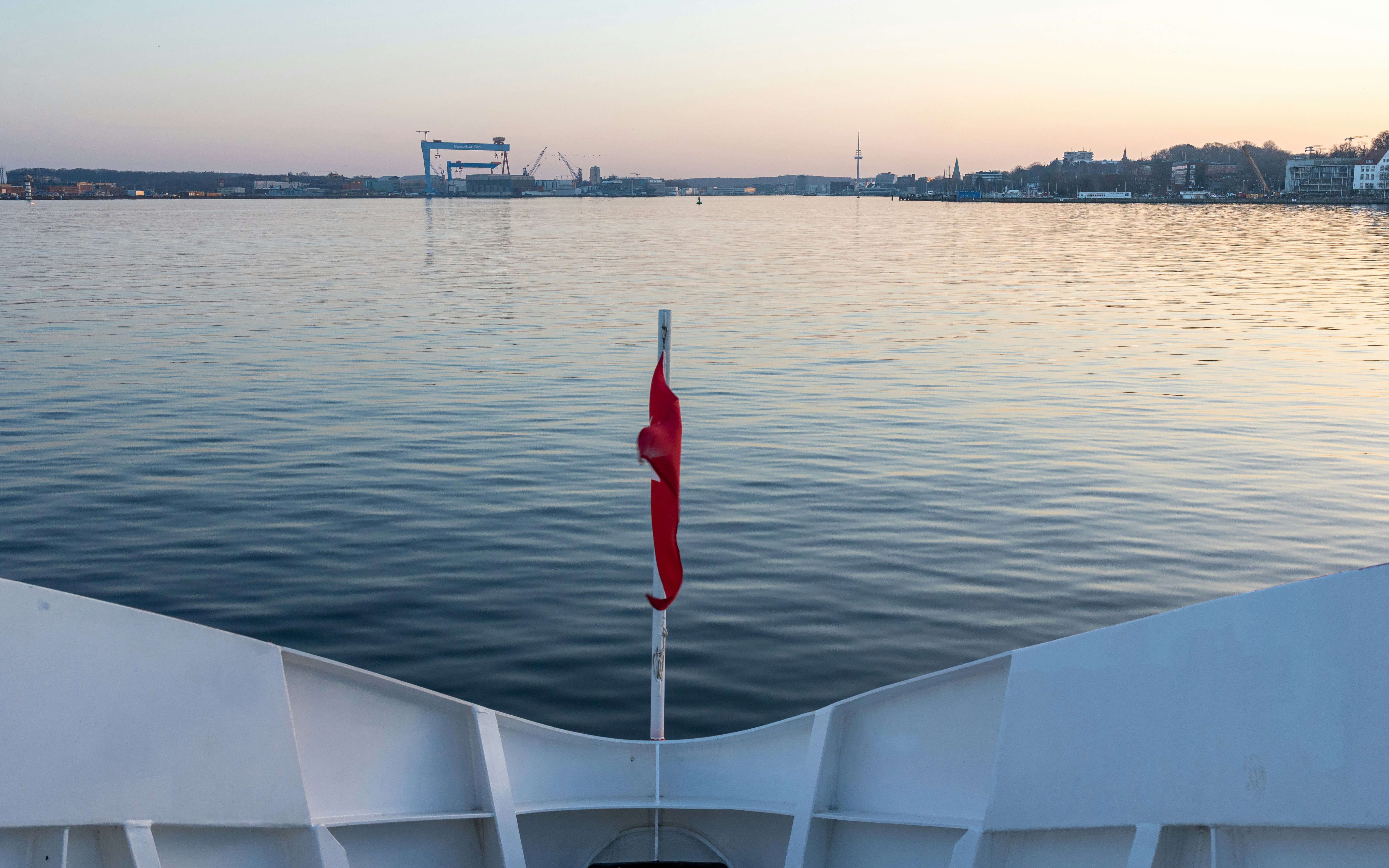 Red Flag on the Bow: A Quiet Harbor at Dusk