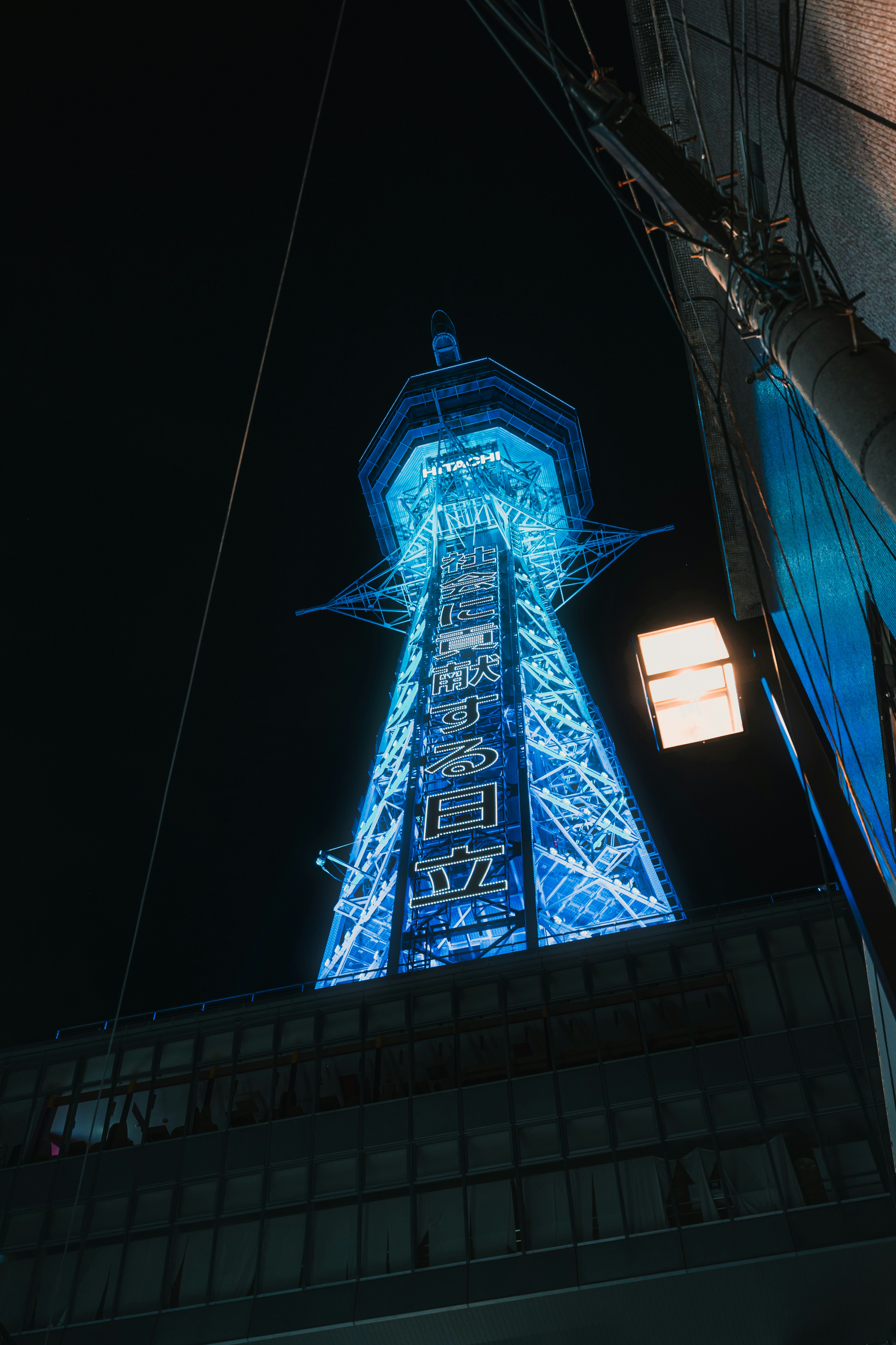 Cobalt Lattice Beacon Rising Over a Quiet Night Street