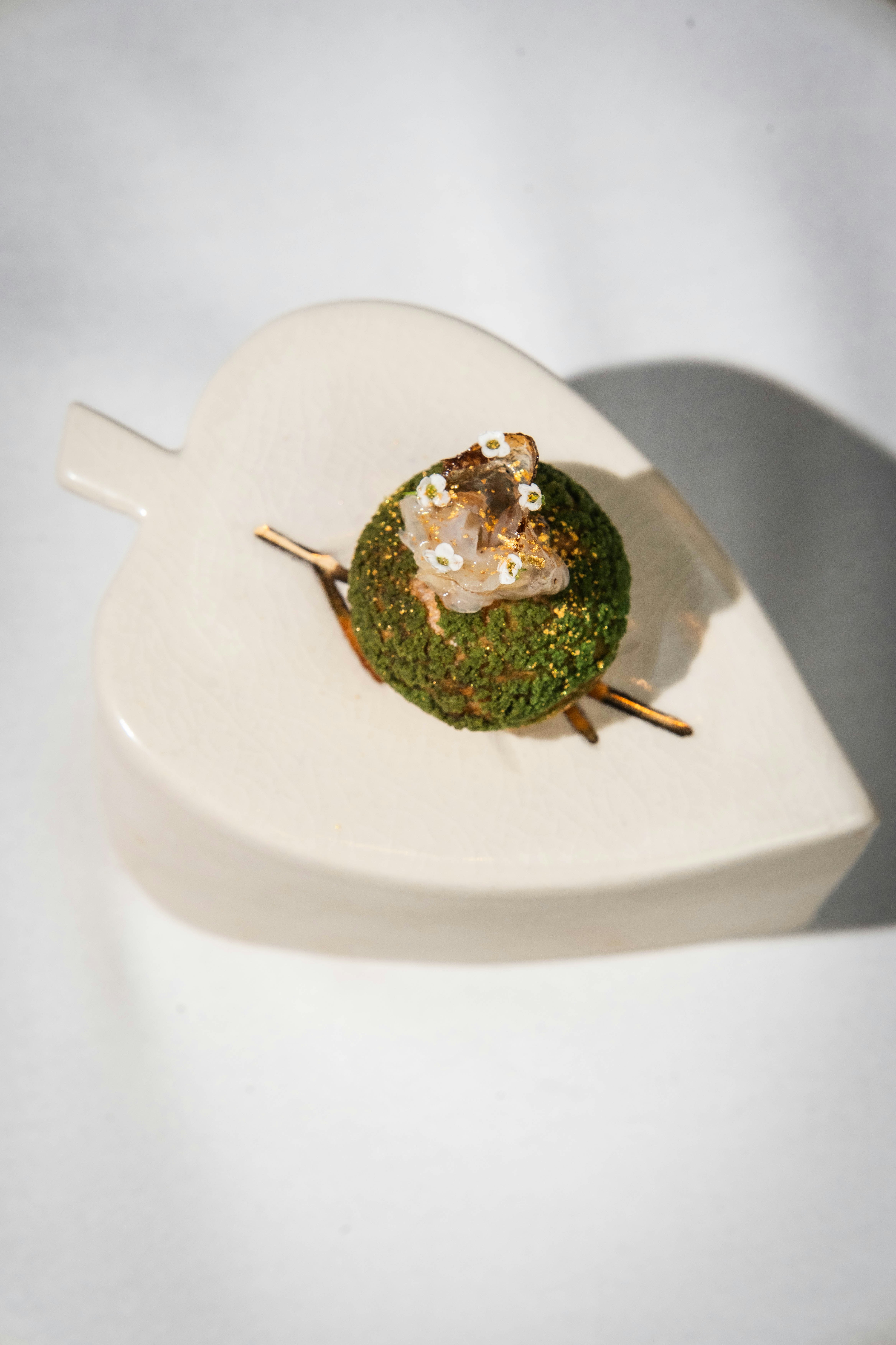 Moss-Kissed Orb on a White Heart Plate with Crystal Accents