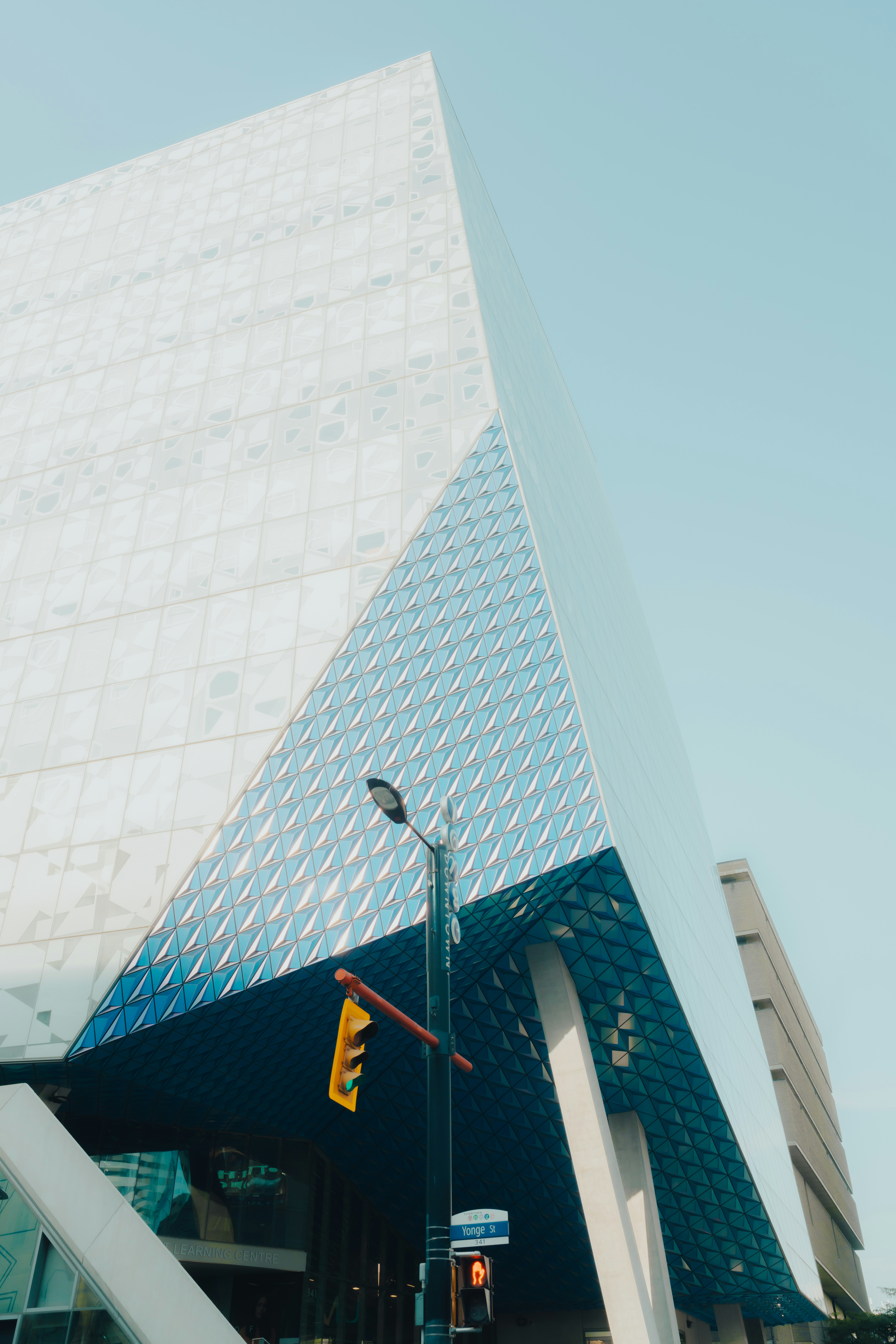 Azure Facade Tilt: A Geometric Corner Reaching Skyward