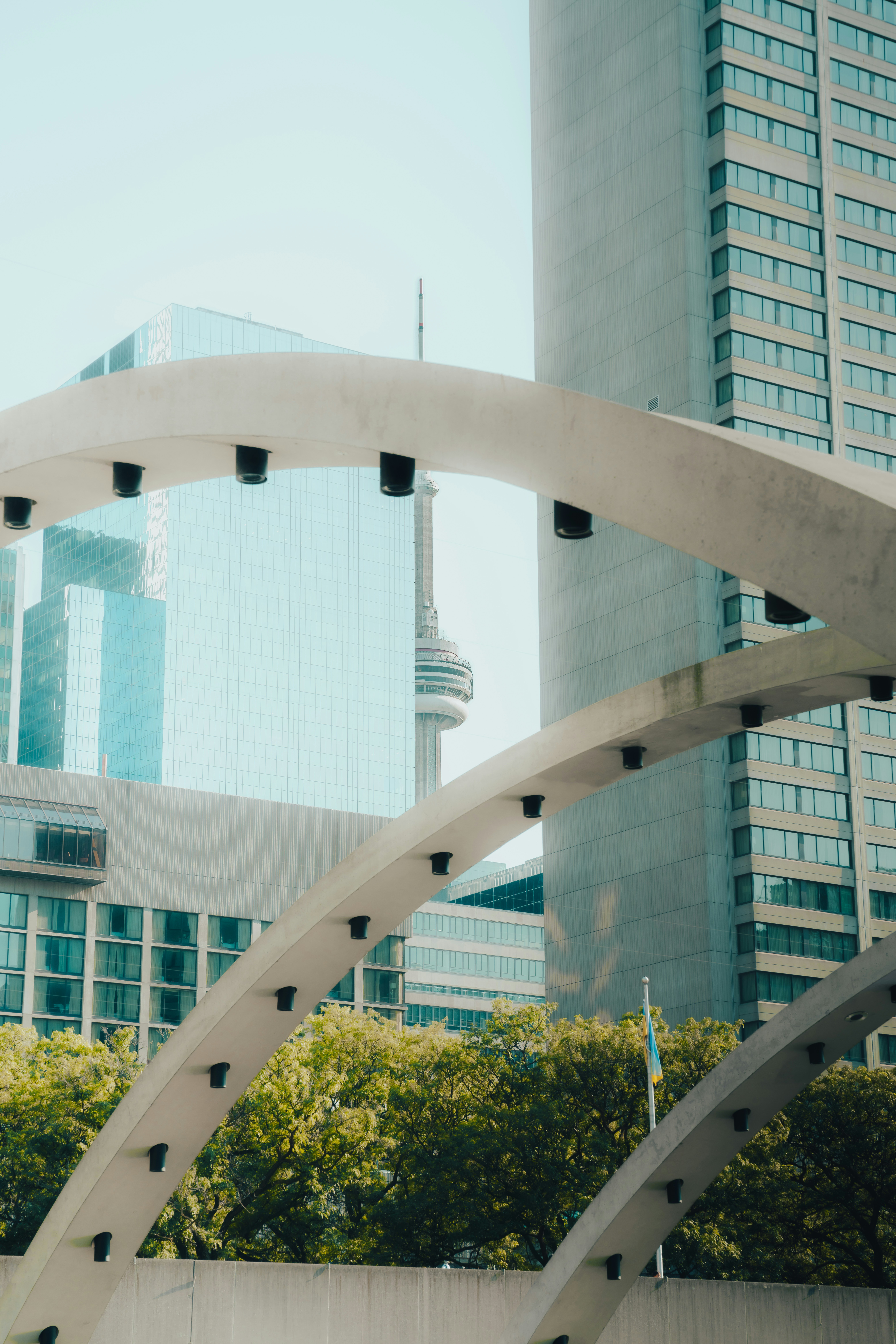Arches and Glass: A Modern Skyline Framed by Concrete Curves