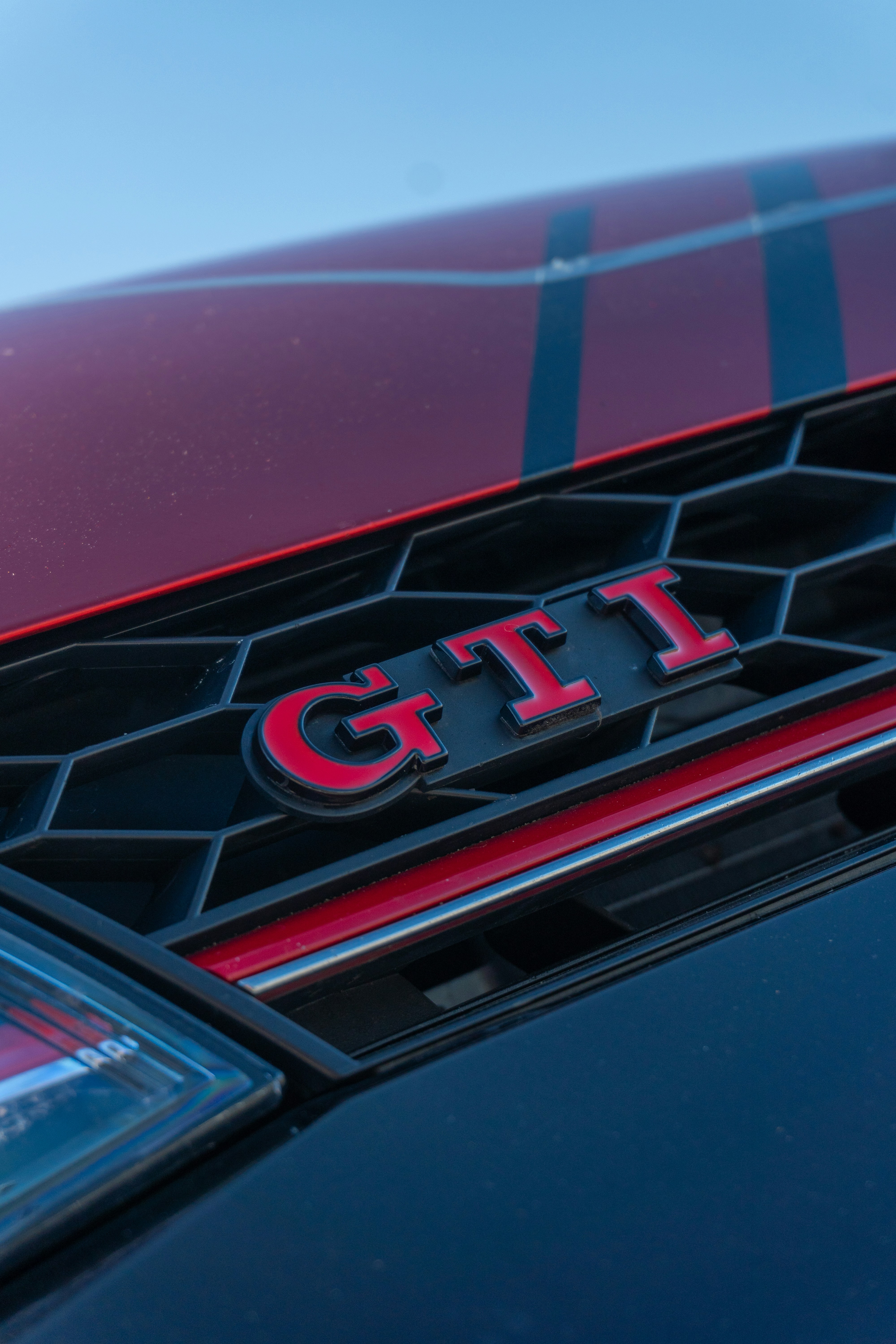 Close-up of a red gti car emblem on grille photo – Free Vehicle Image ...