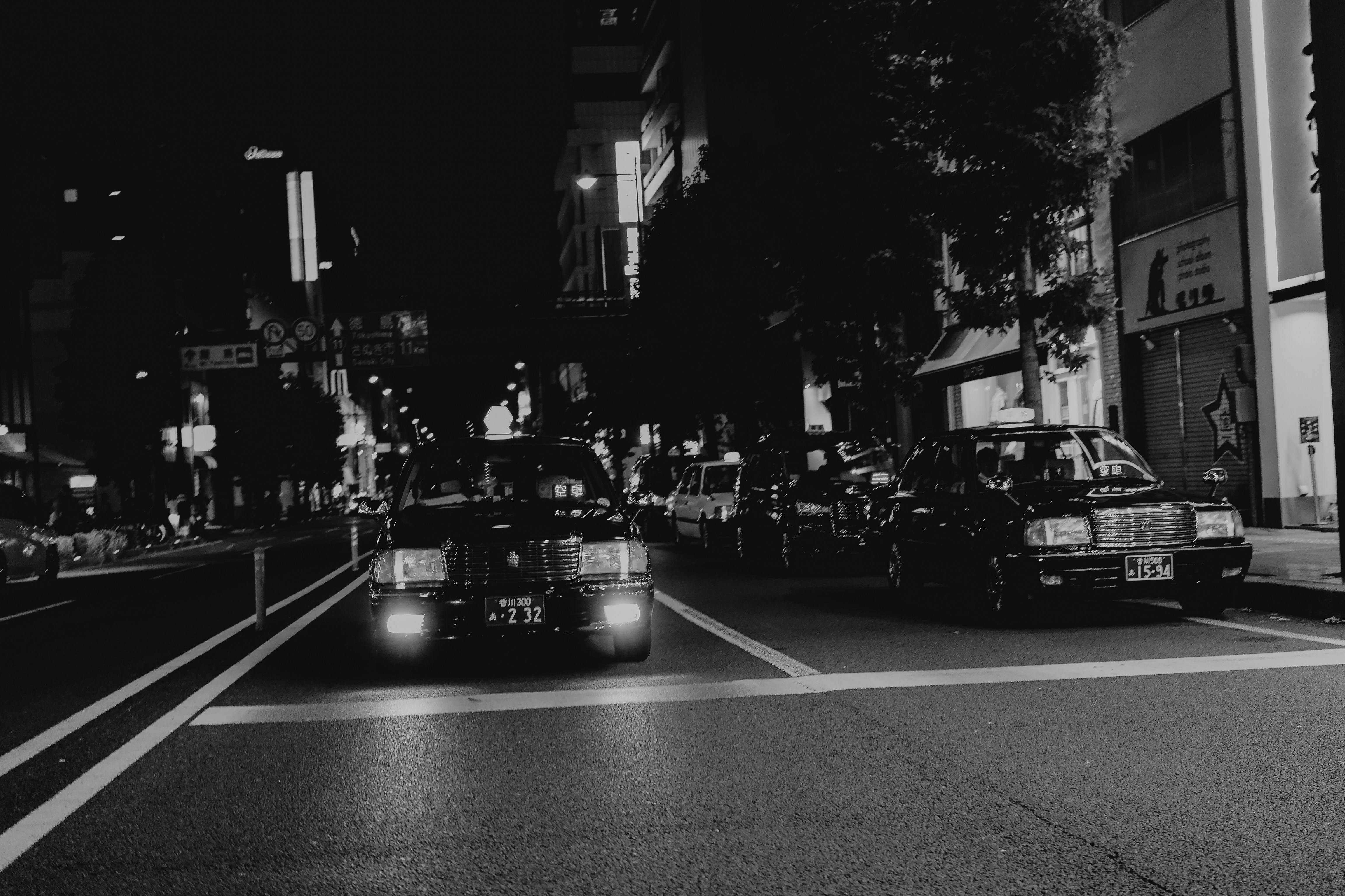 Taxis driving on a city street at night