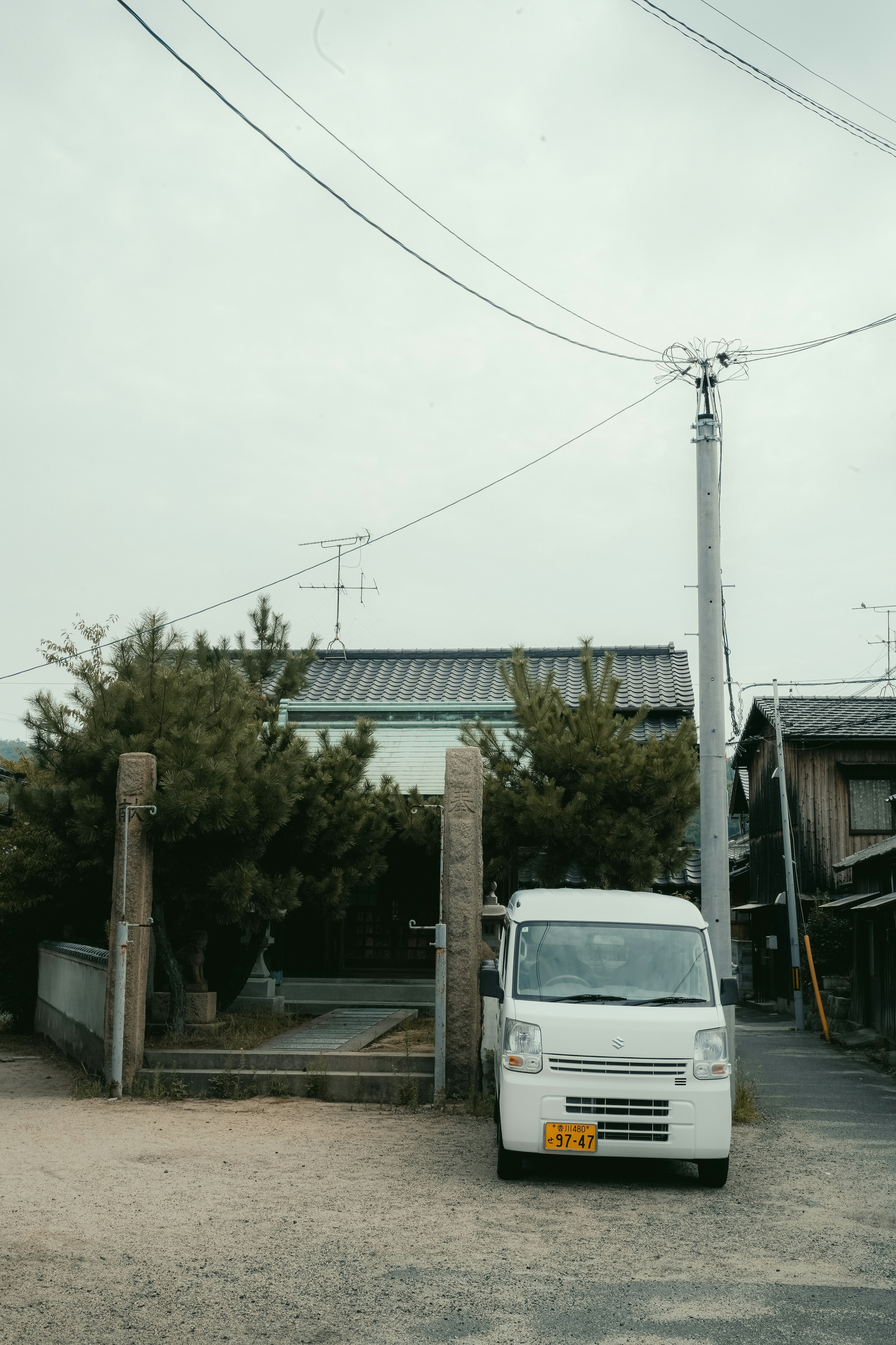 White van parked in front of a building.