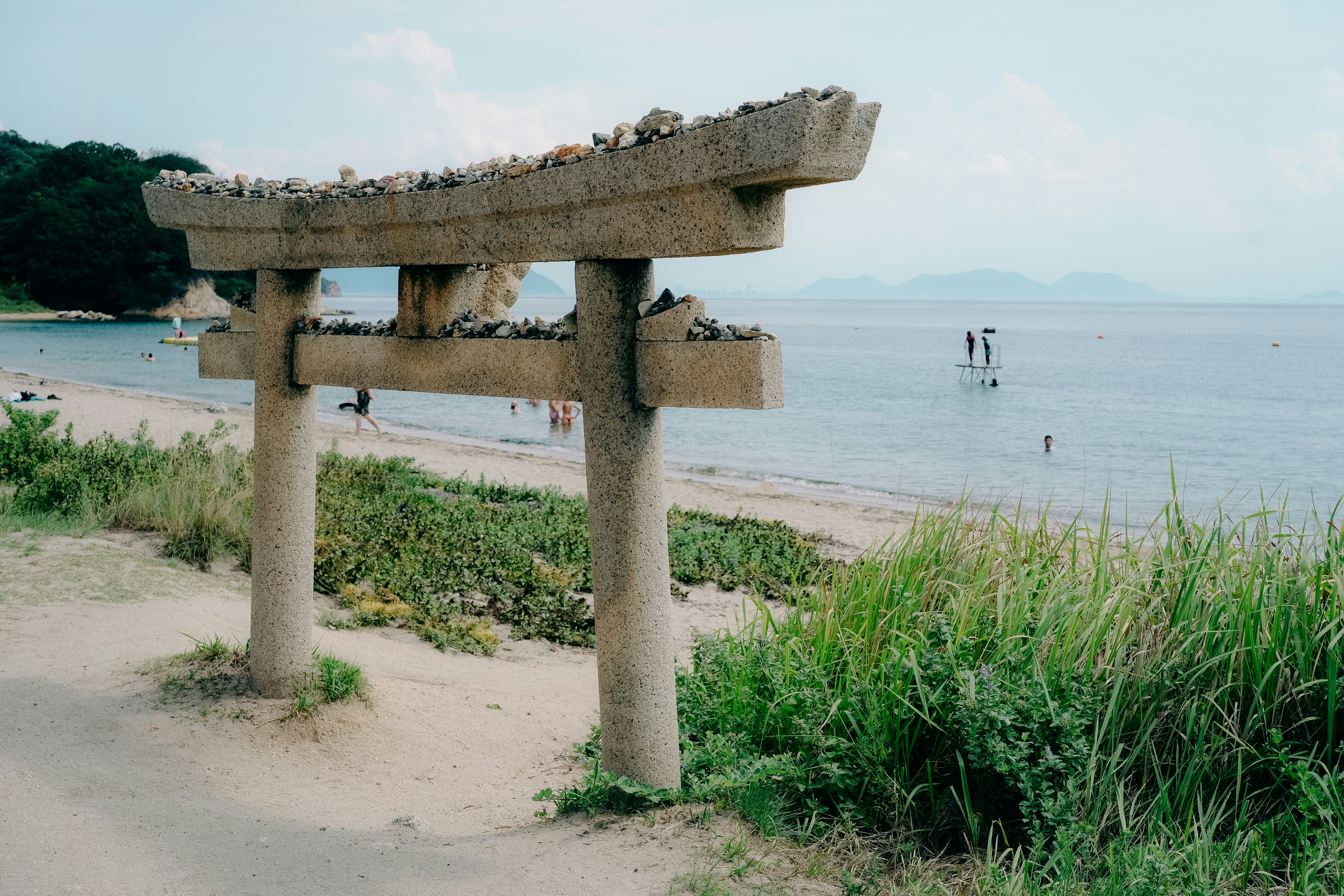 Seaside Torii: A Weathered Gate Framing the Quiet Shore