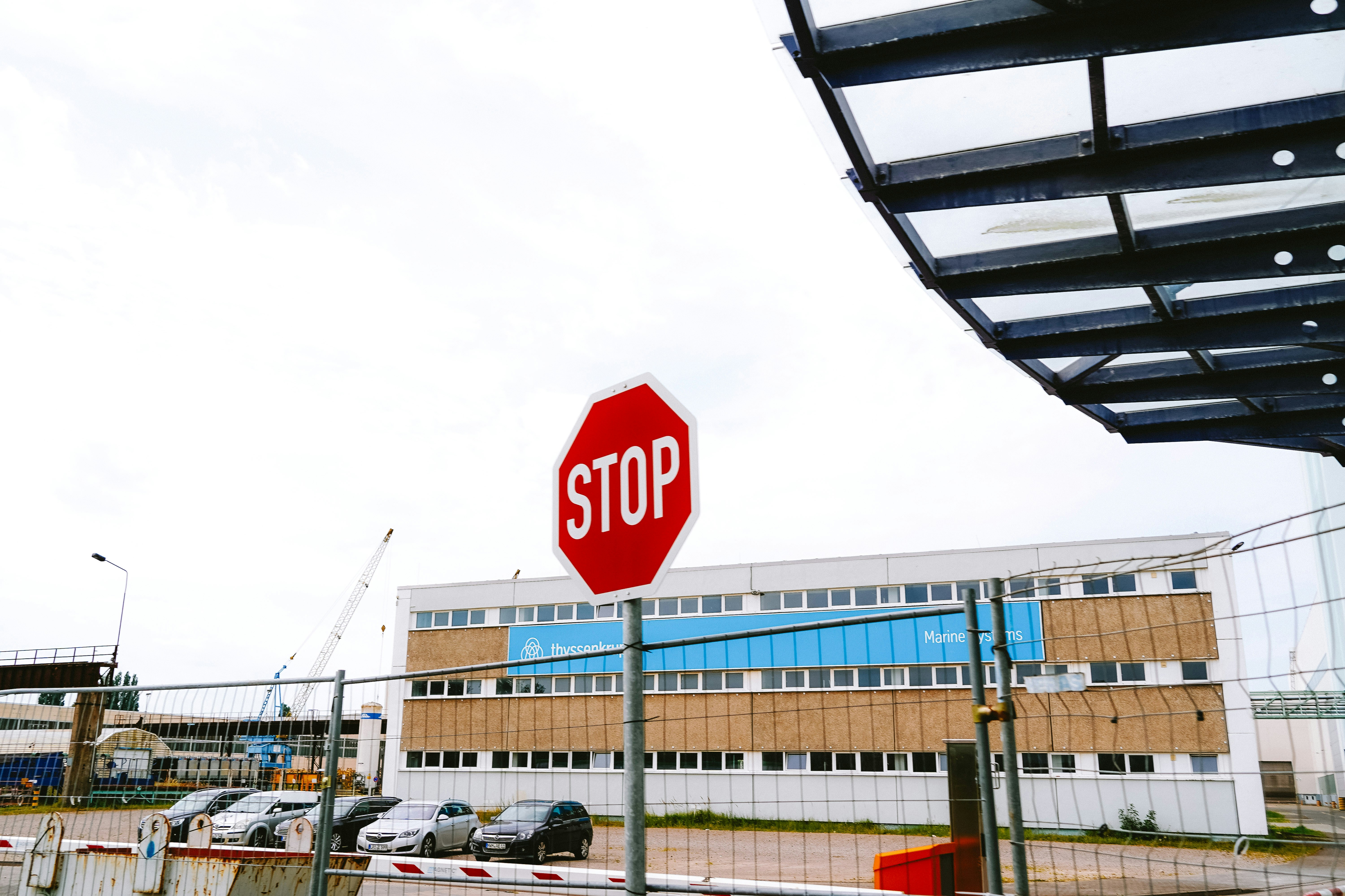 stop sign at industrial site | Stop sign in front of a modern building