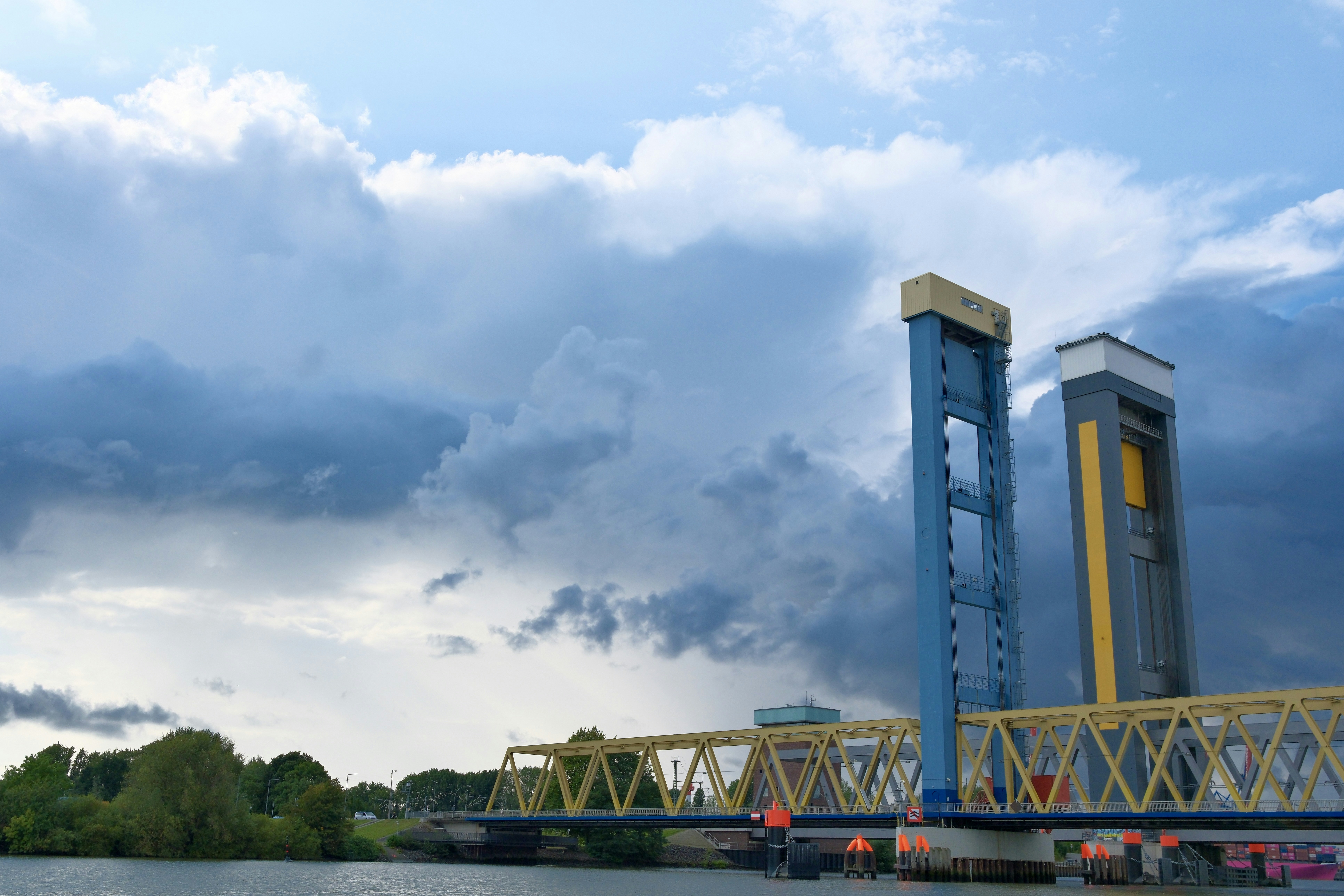 A vertical lift bridge over a body of water. photo – Free Clouds Image ...