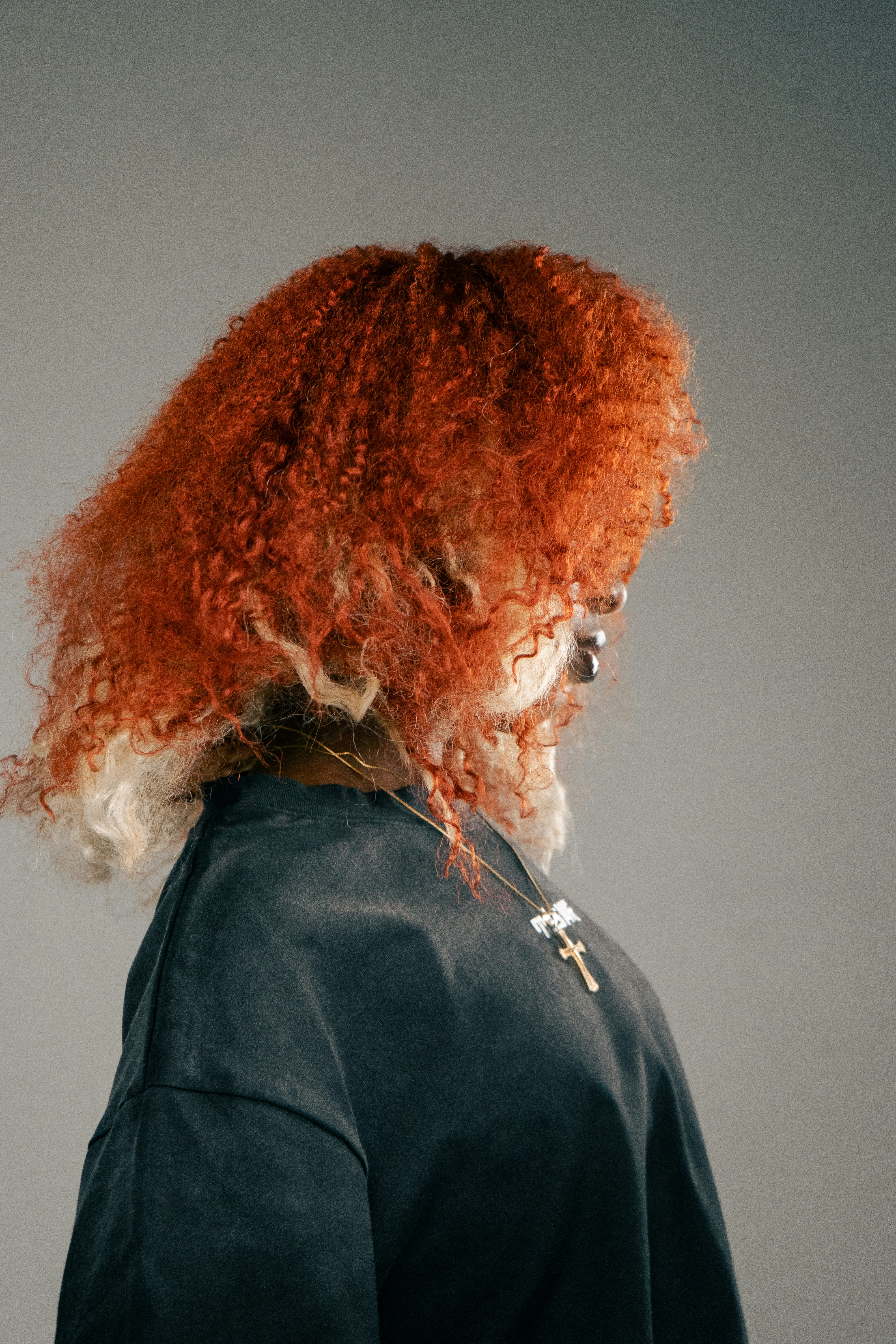 Woman with vibrant curly red and blonde hair