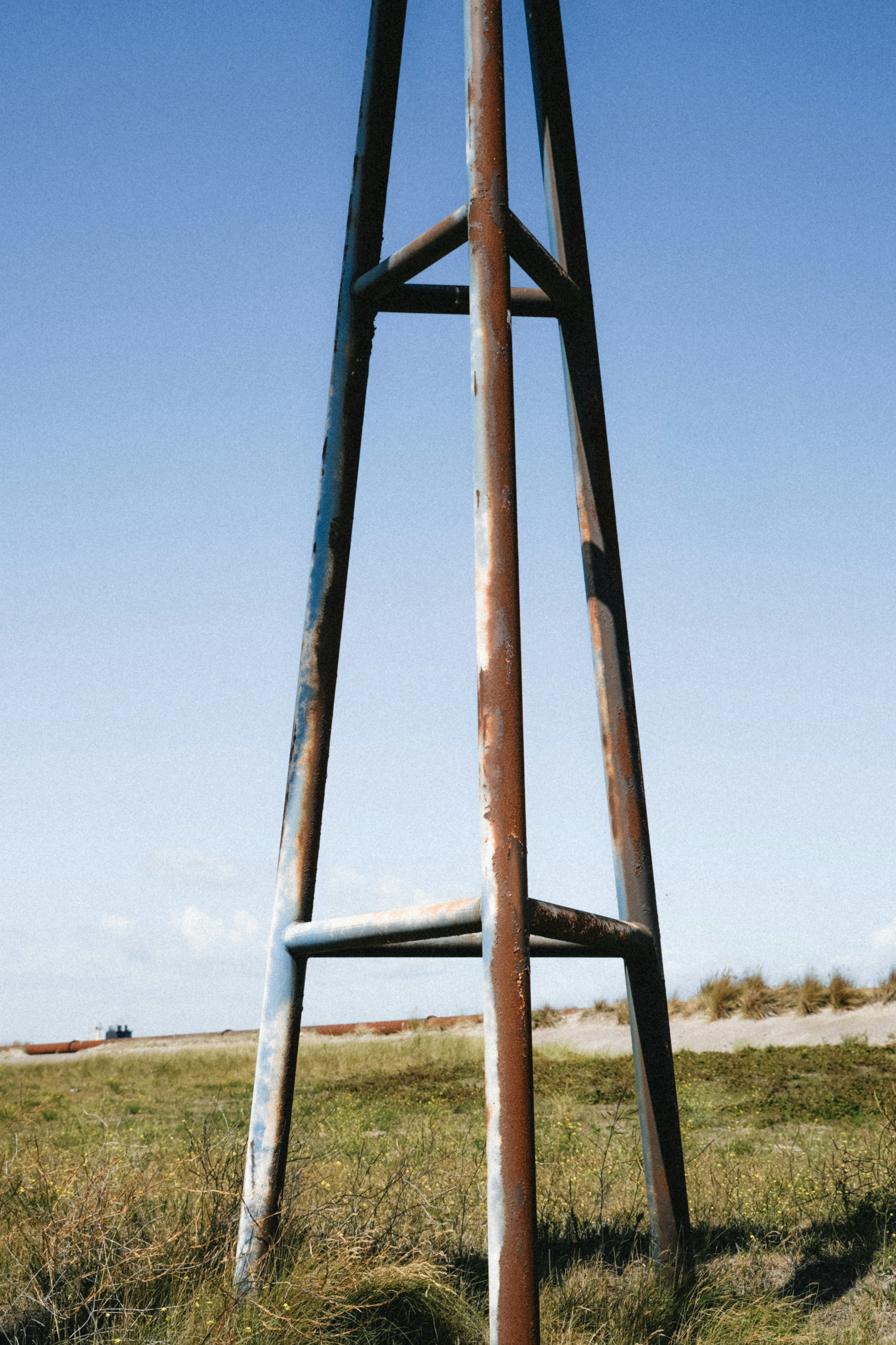 Rusty metal structure against a clear blue sky