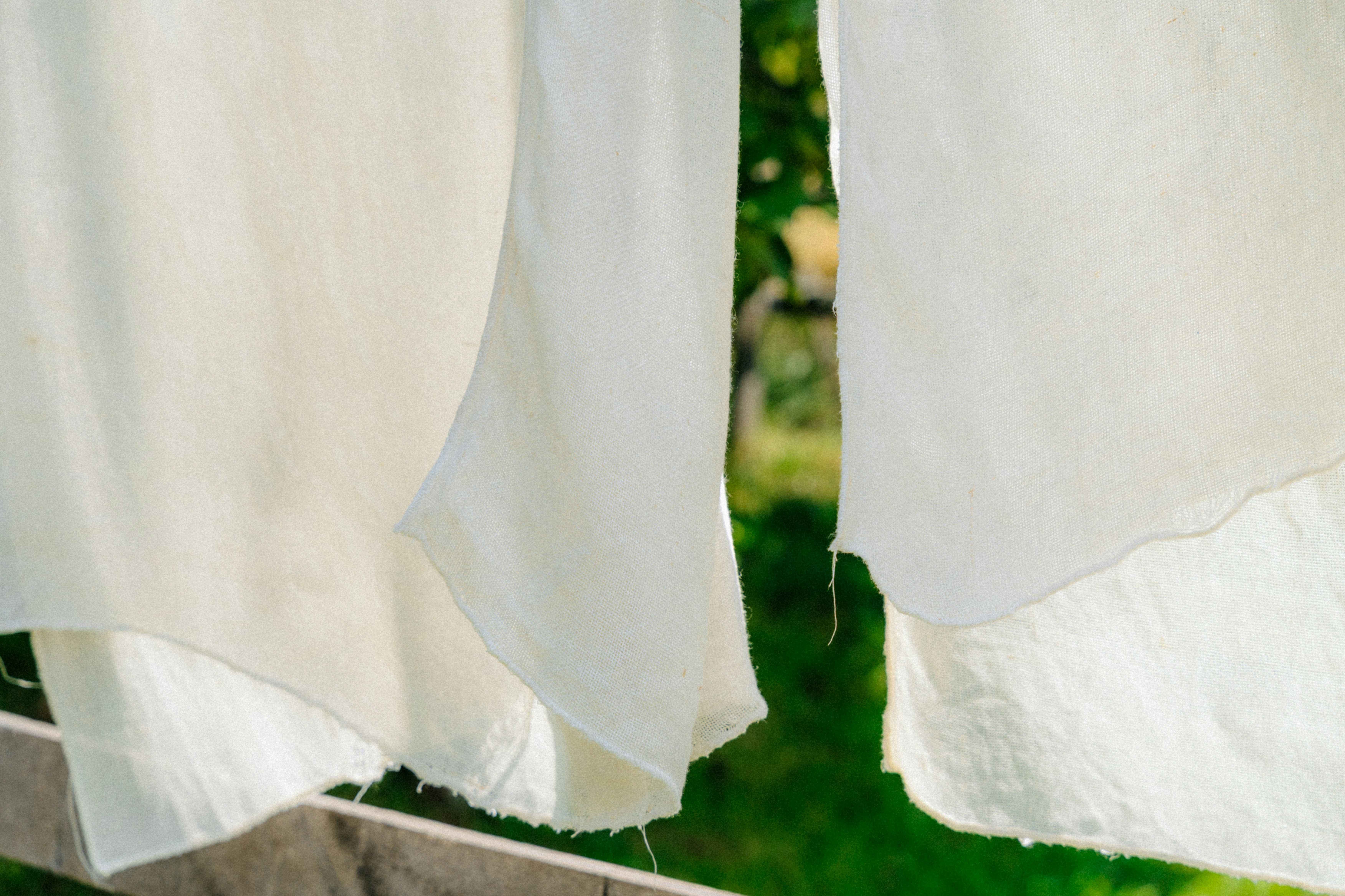 White fabric drying in the sun outdoors