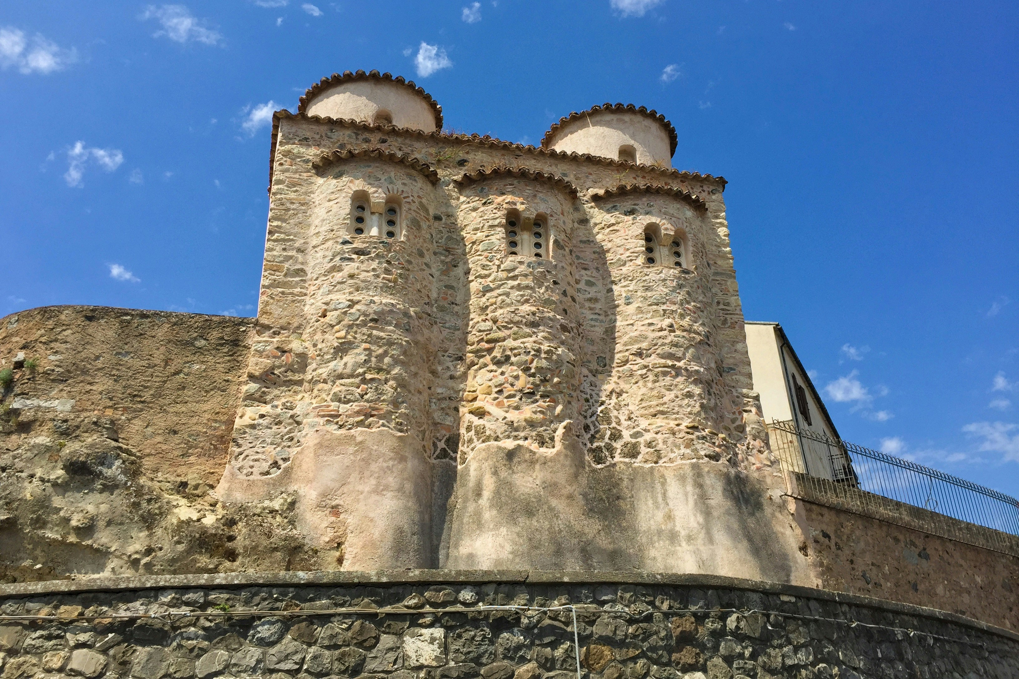 Stone church with two domes against blue sky