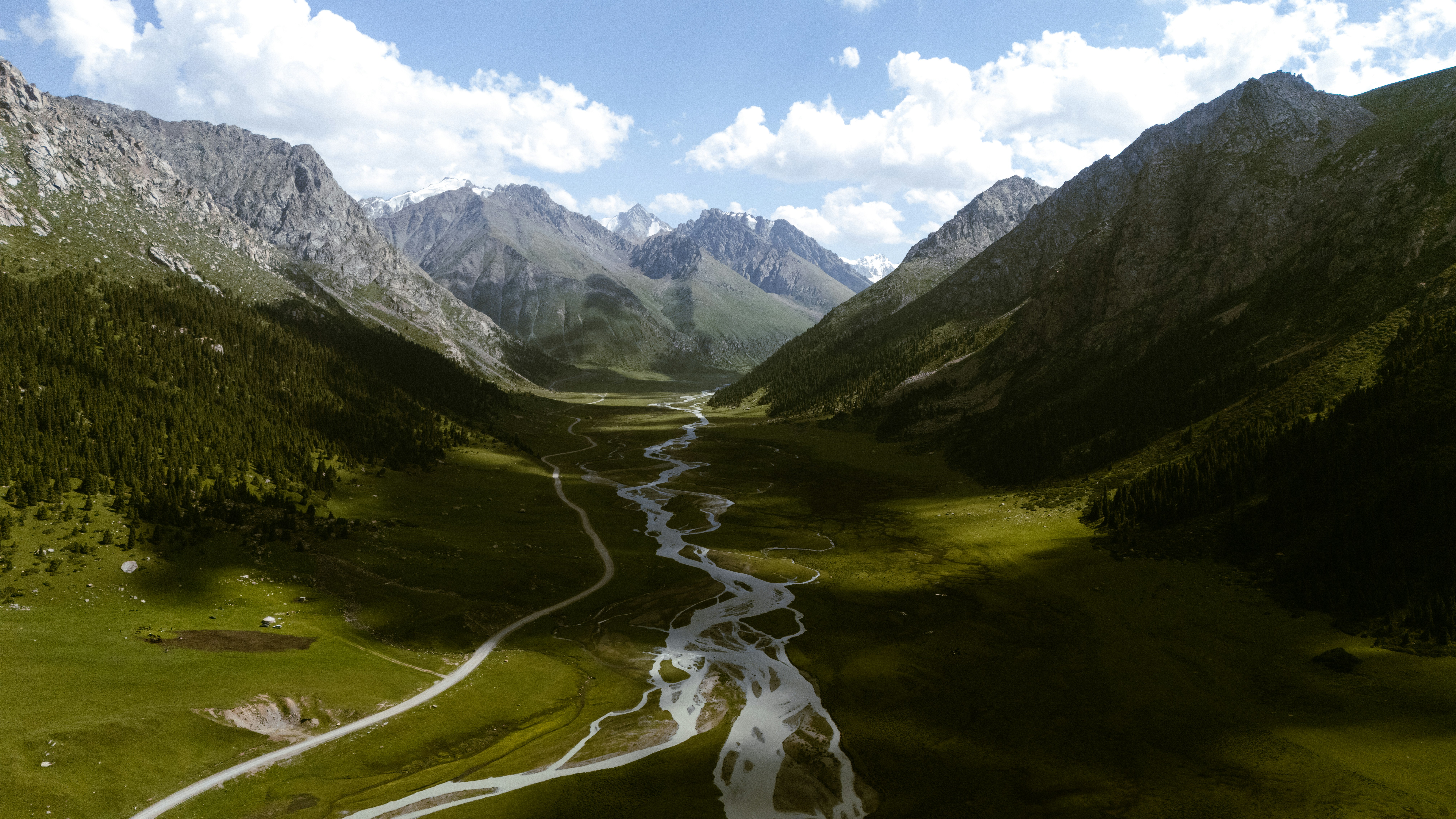 River winding through a lush green mountain valley.