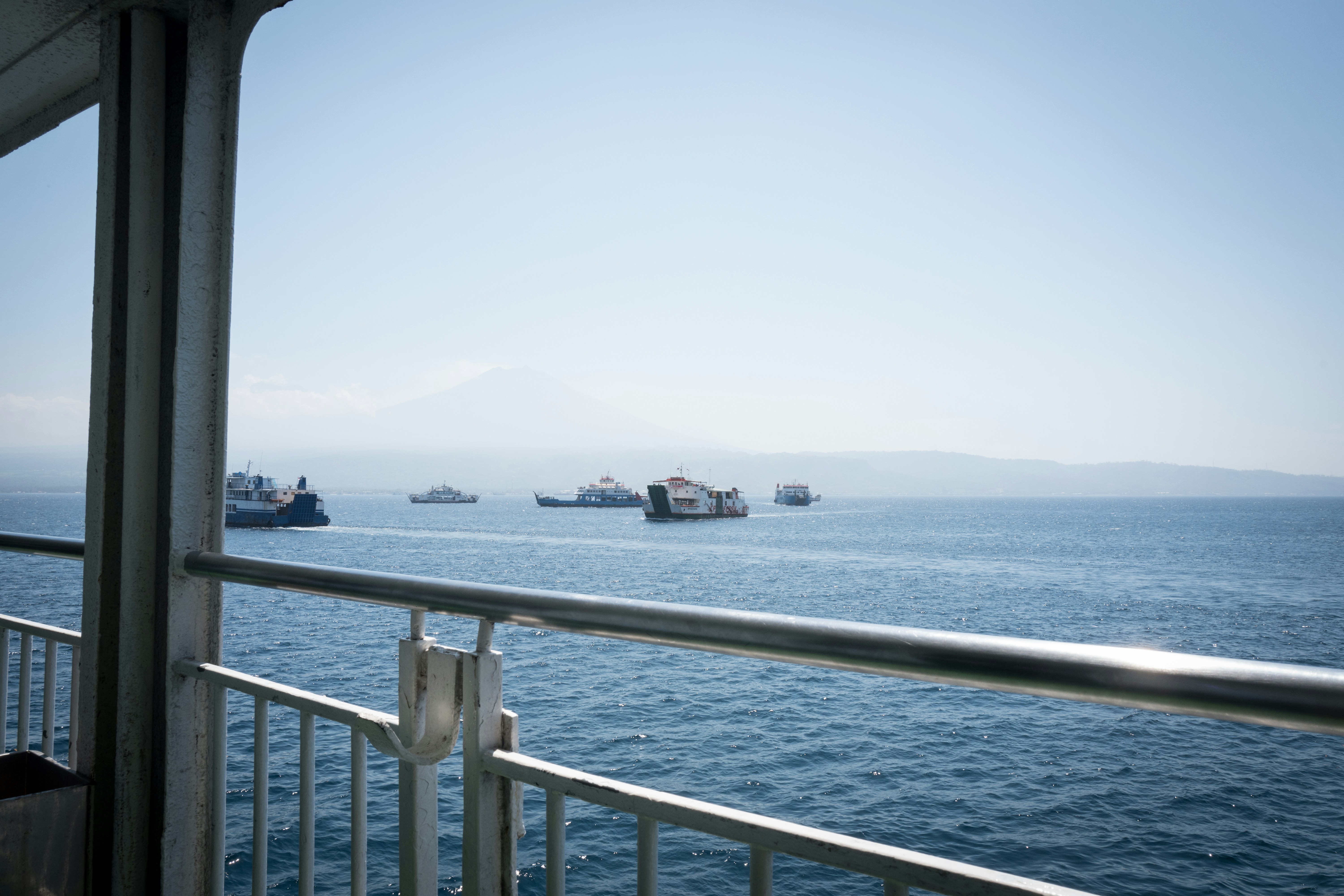 Ferries sailing on a calm blue ocean.