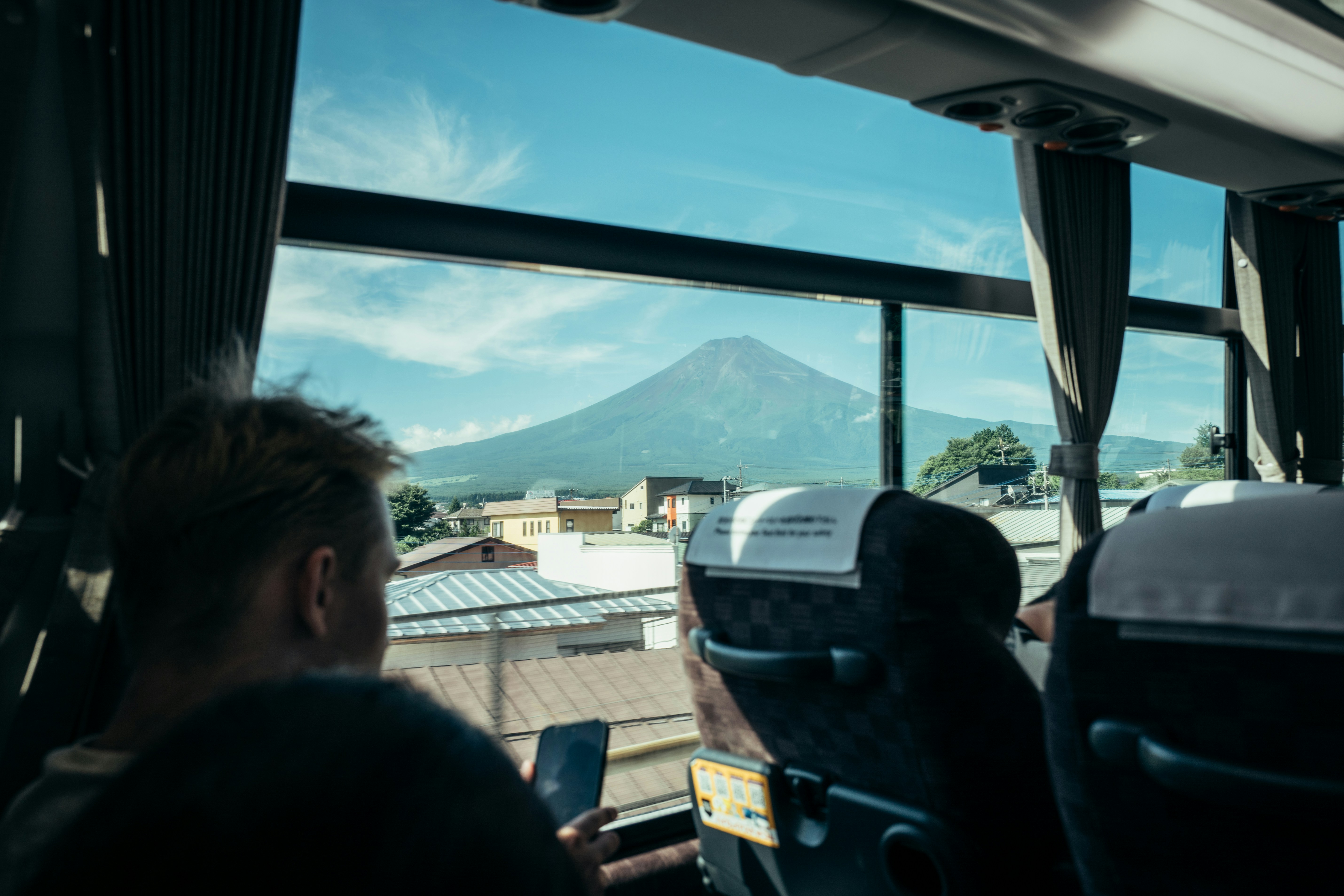 View of mount fuji from a moving bus window.