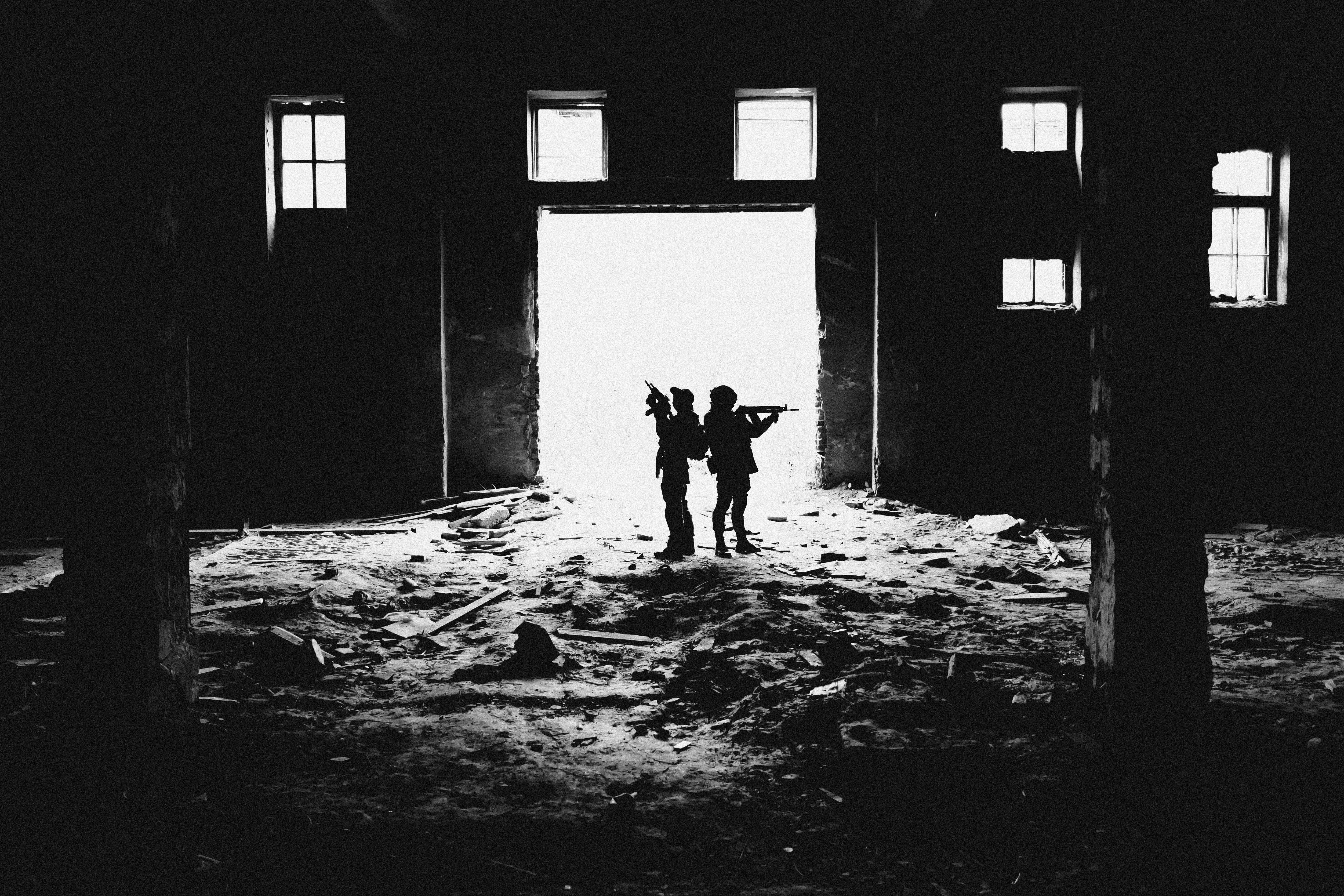Two figures stand silhouetted in a doorway.