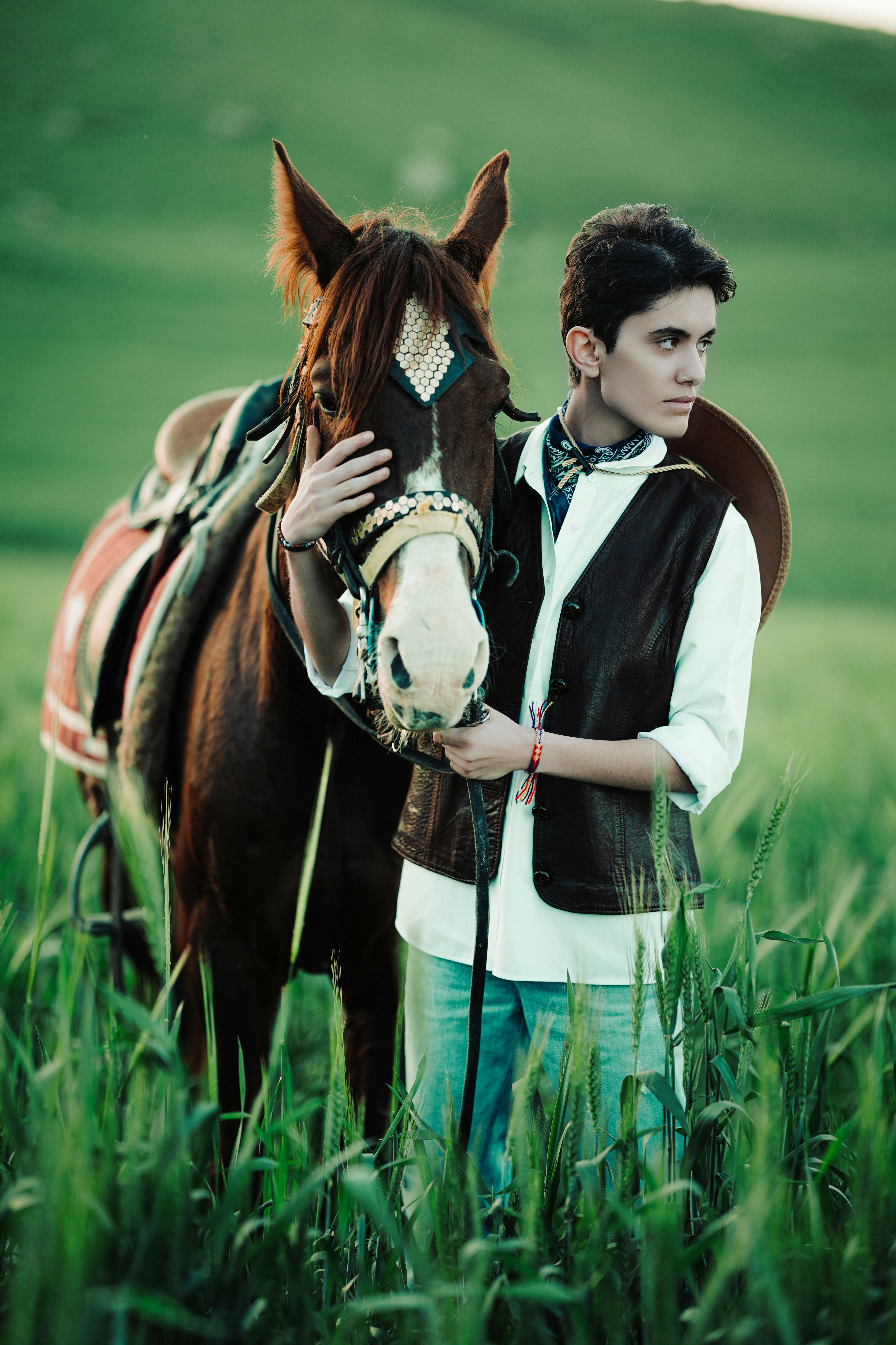 Person with horse in a grassy field